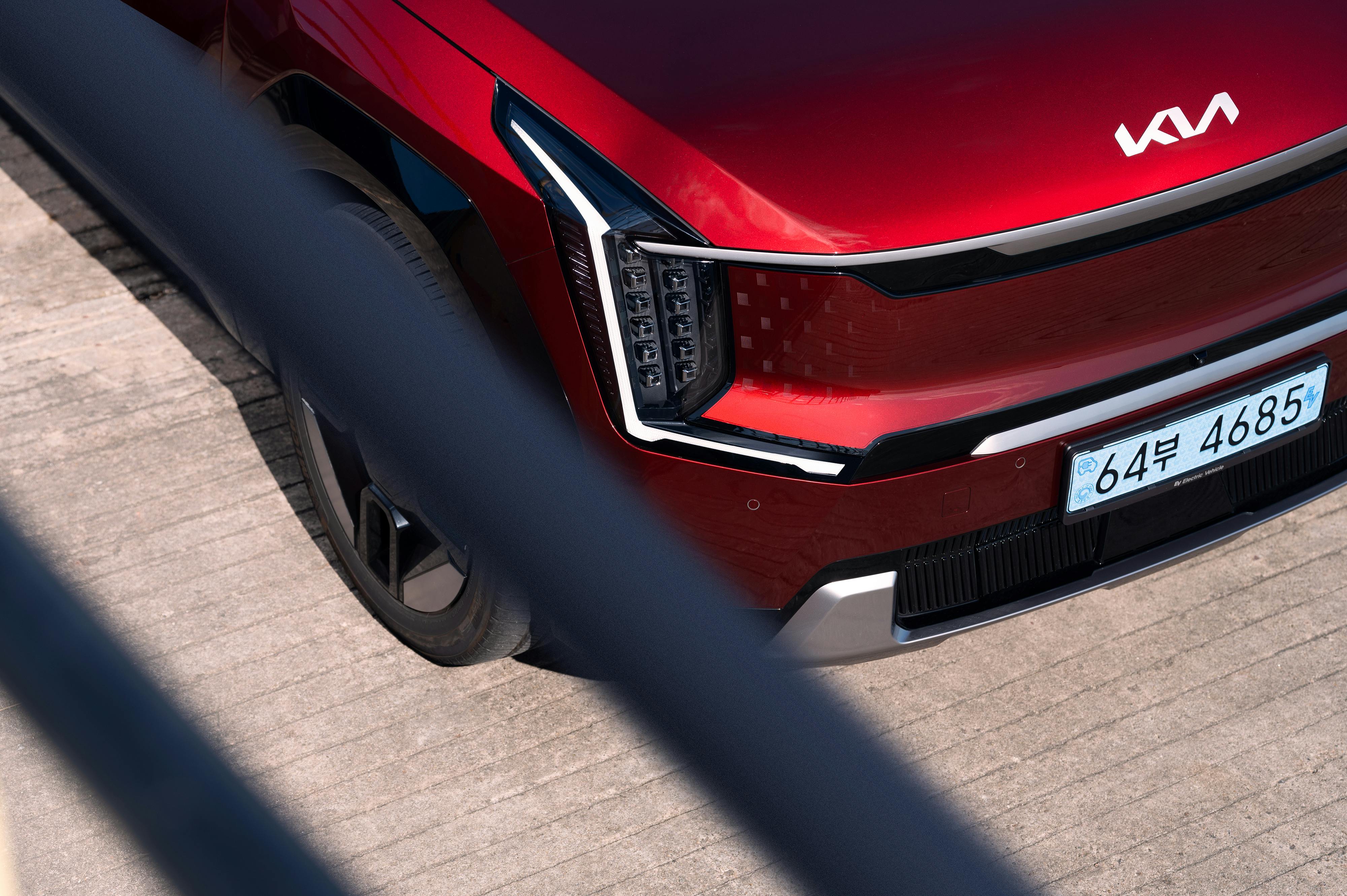 Red Electric SUV Kia EV9 on Concrete Surface · Free Stock Photo