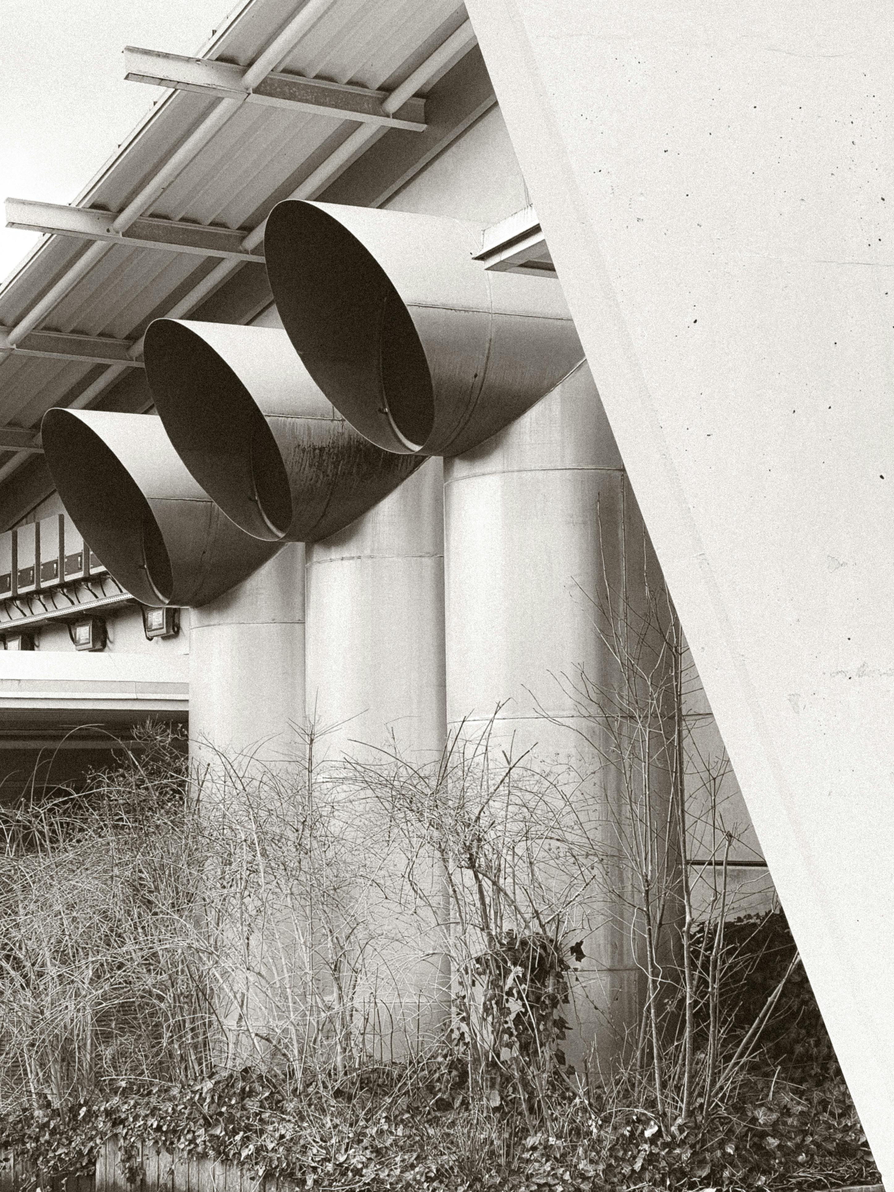 Photo of Large Pipes Outside of an Industrial Building · Free Stock Photo