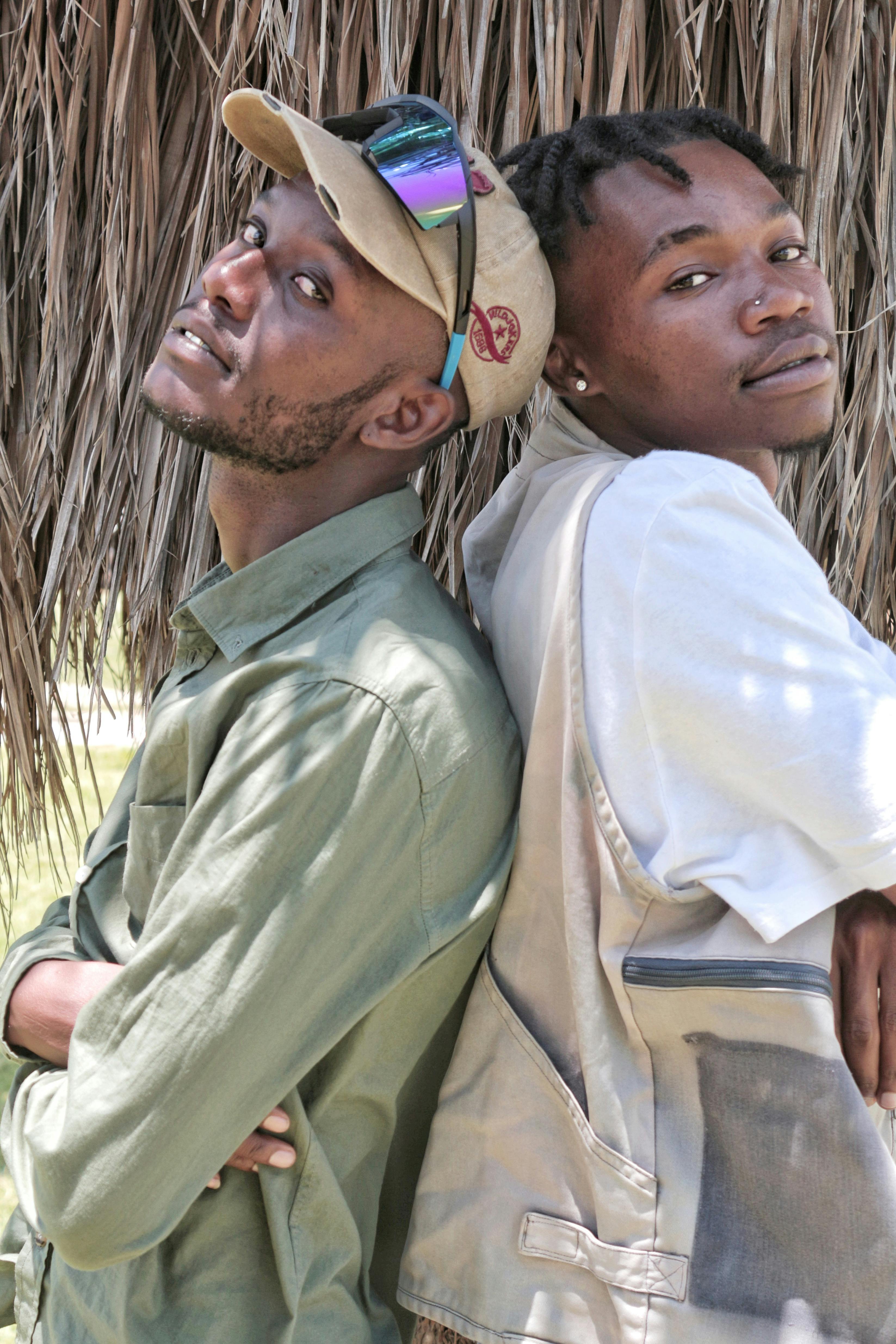 Two Men Standing Back to Back · Free Stock Photo
