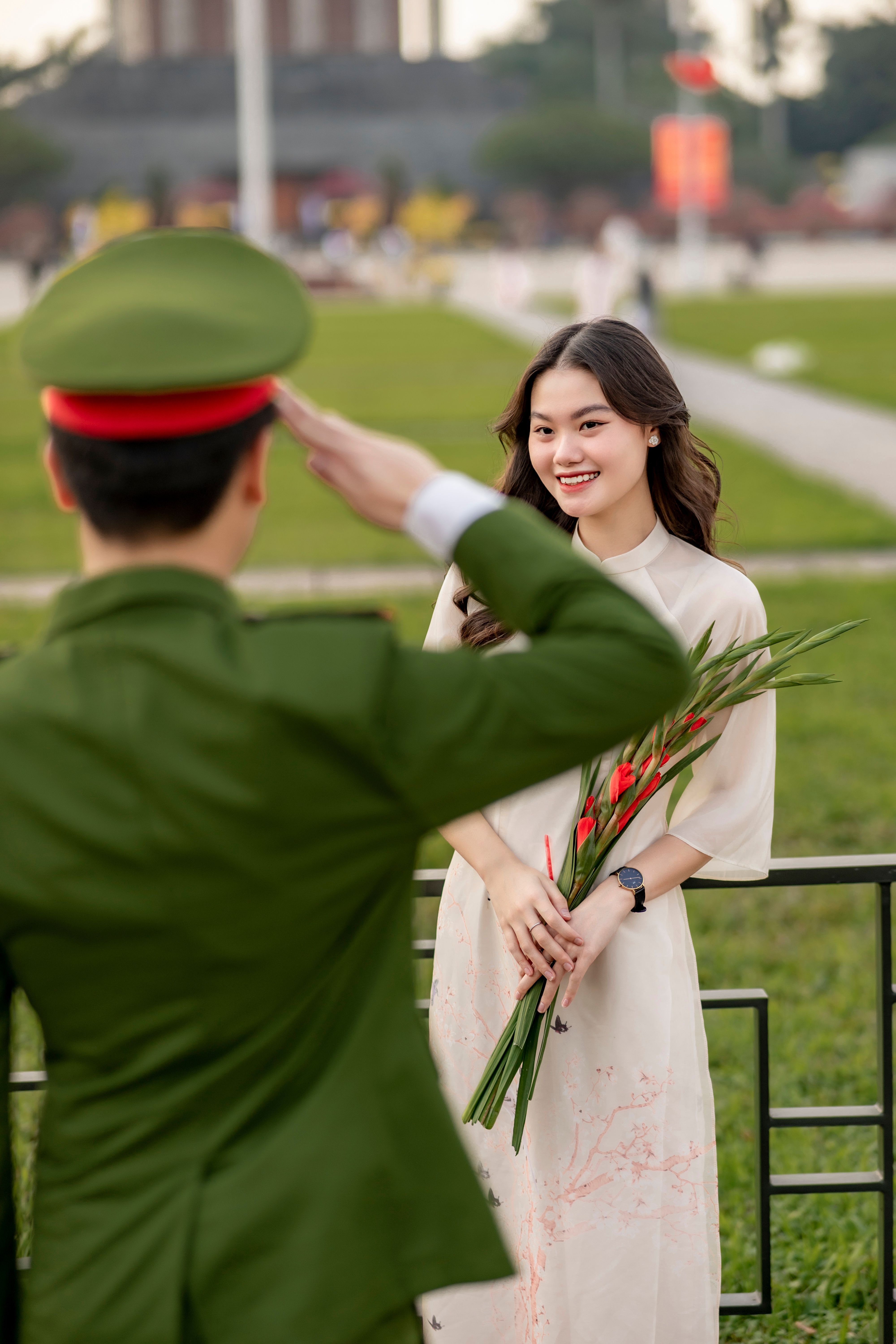 Soldier Saluting a Pretty Brunette Holding a Bunch of Flowers · Free ...
