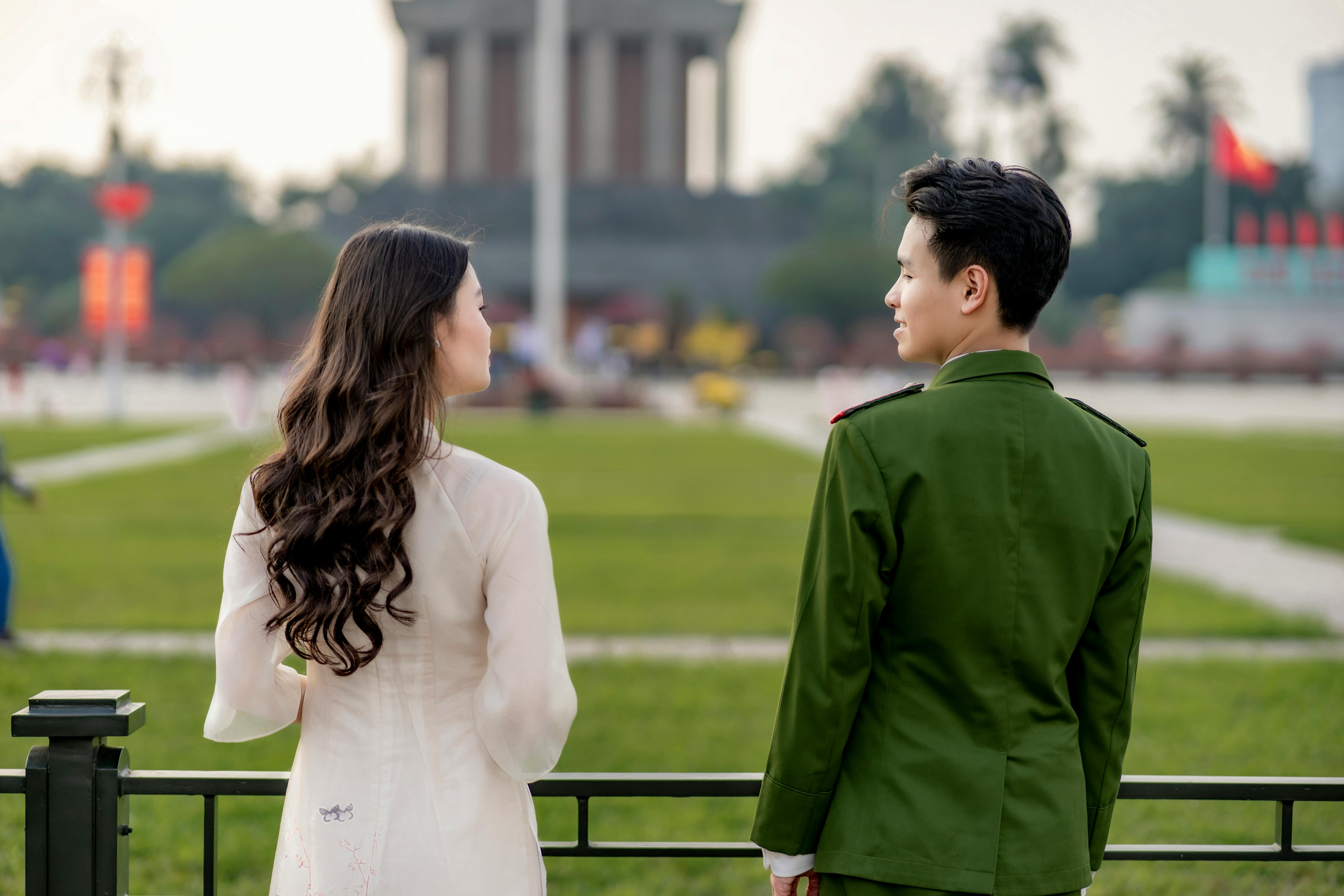 Soldier and a Young Woman Standing Together in Front of the Ho Chi ...
