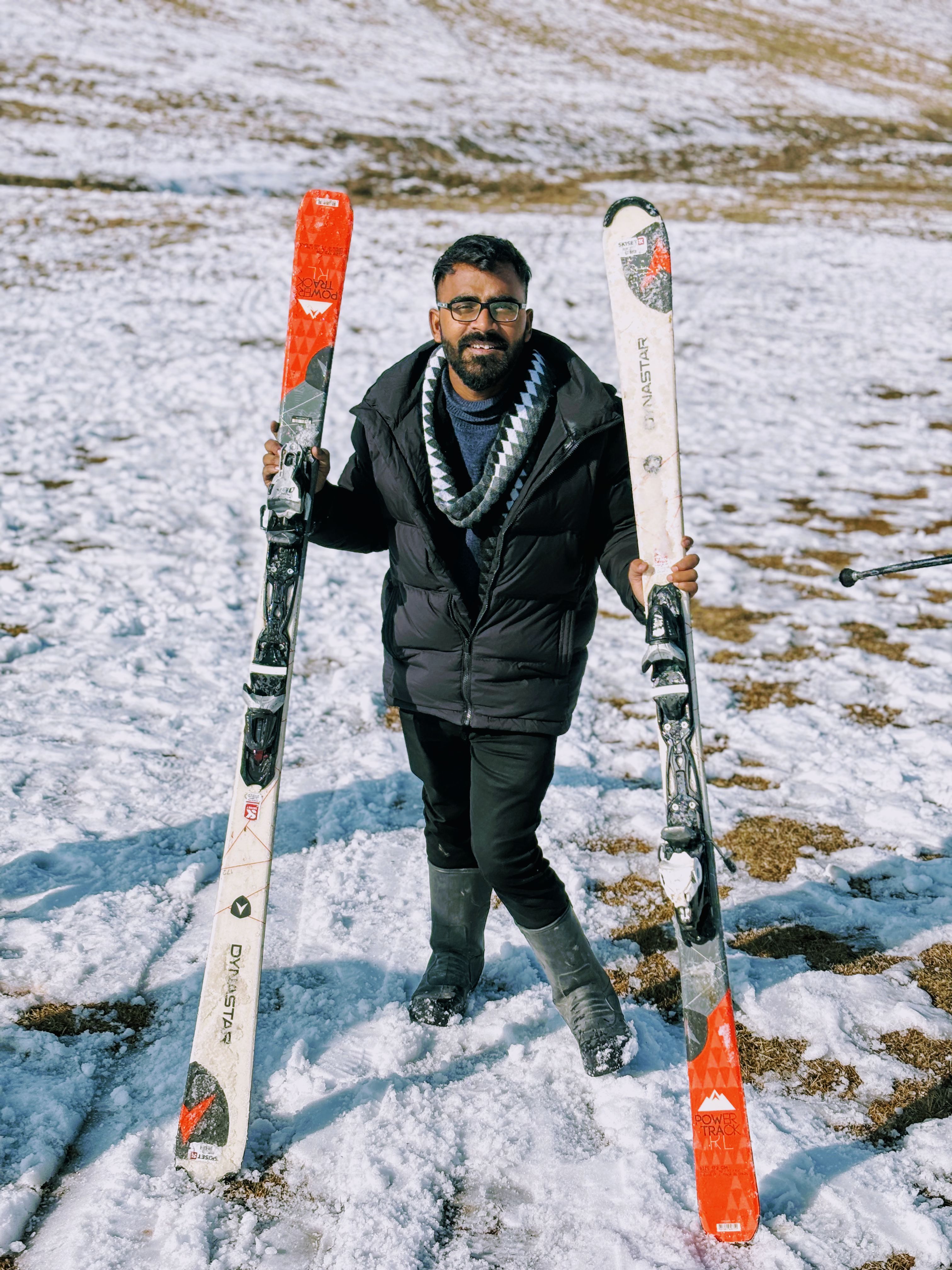 Portrait of a Man Standing Outdoors with Skis in Hands · Free Stock Photo