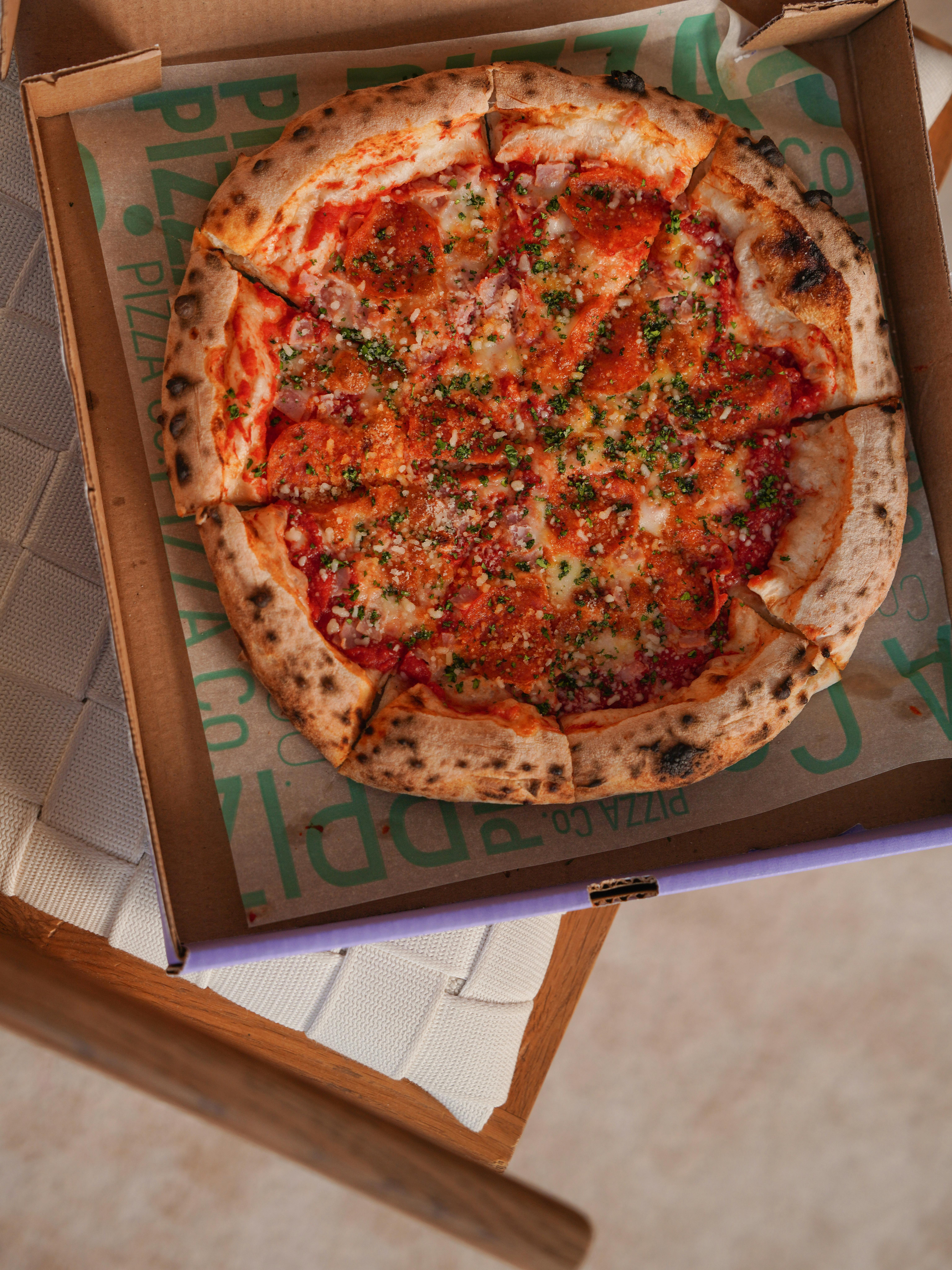Top View of a Neapolitan Pizza in a Box · Free Stock Photo