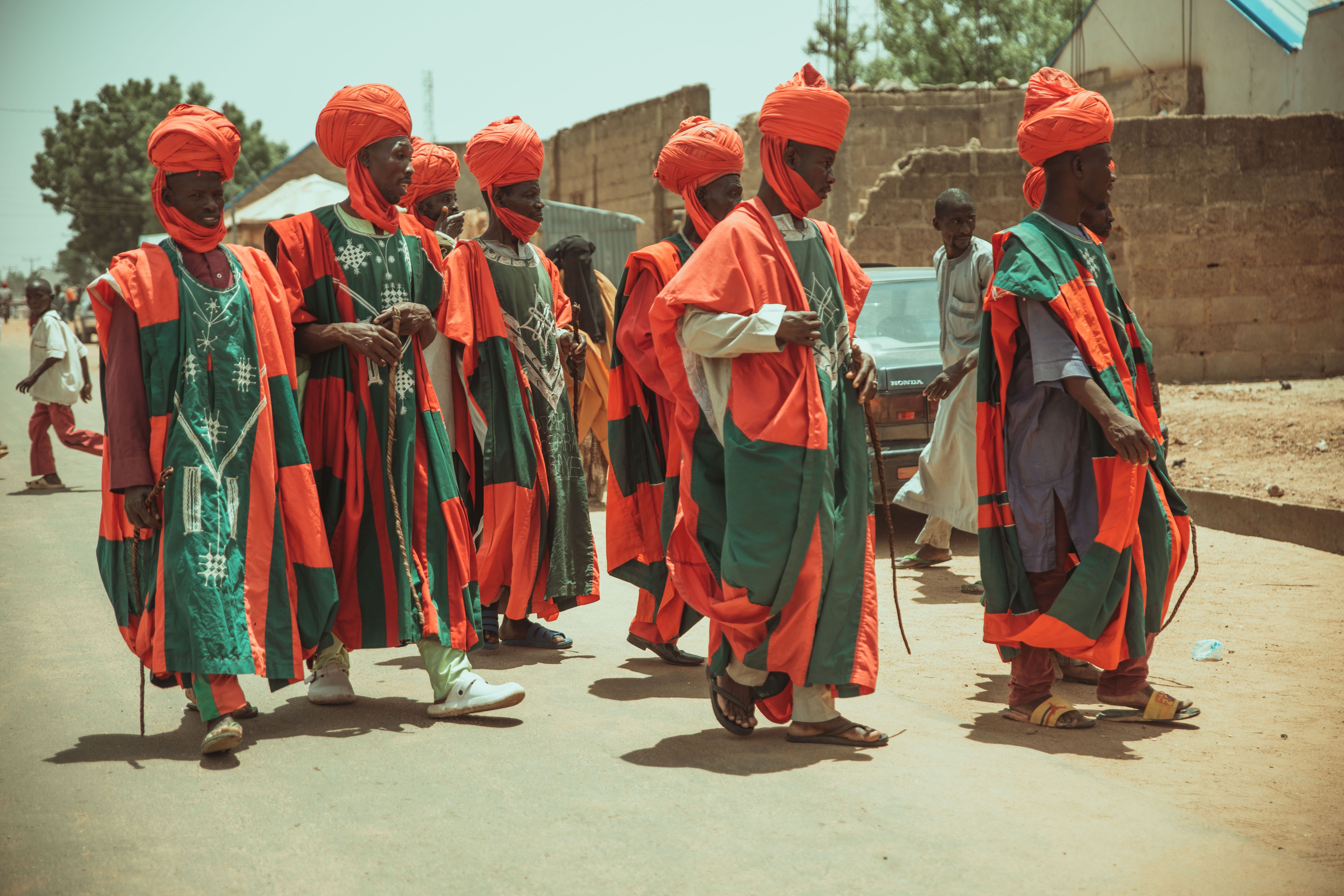 Men Walking in Traditional Clothing on Street in Village · Free Stock Photo