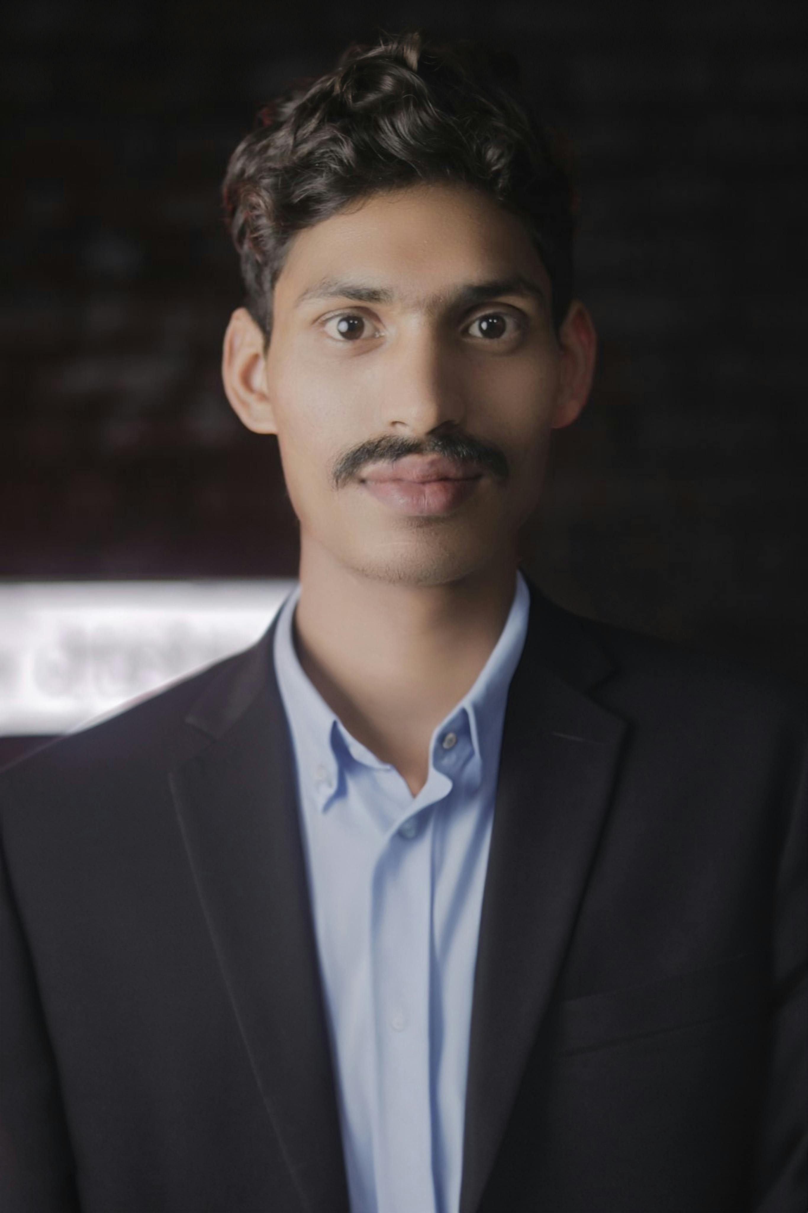 Man in Black Suit Holding a Calling Card · Free Stock Photo