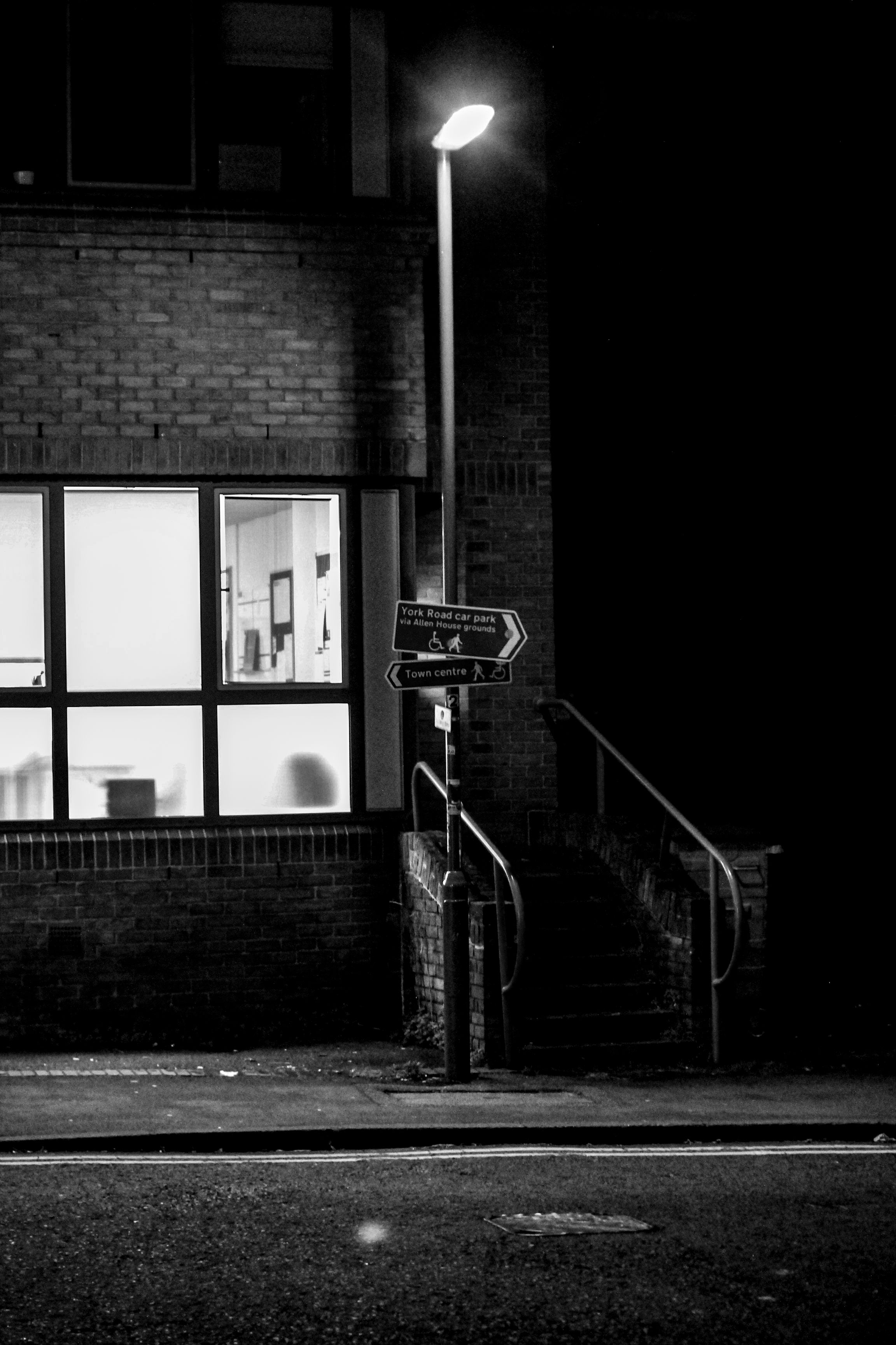 Signs on Street Lamp by Street in City at Night · Free Stock Photo