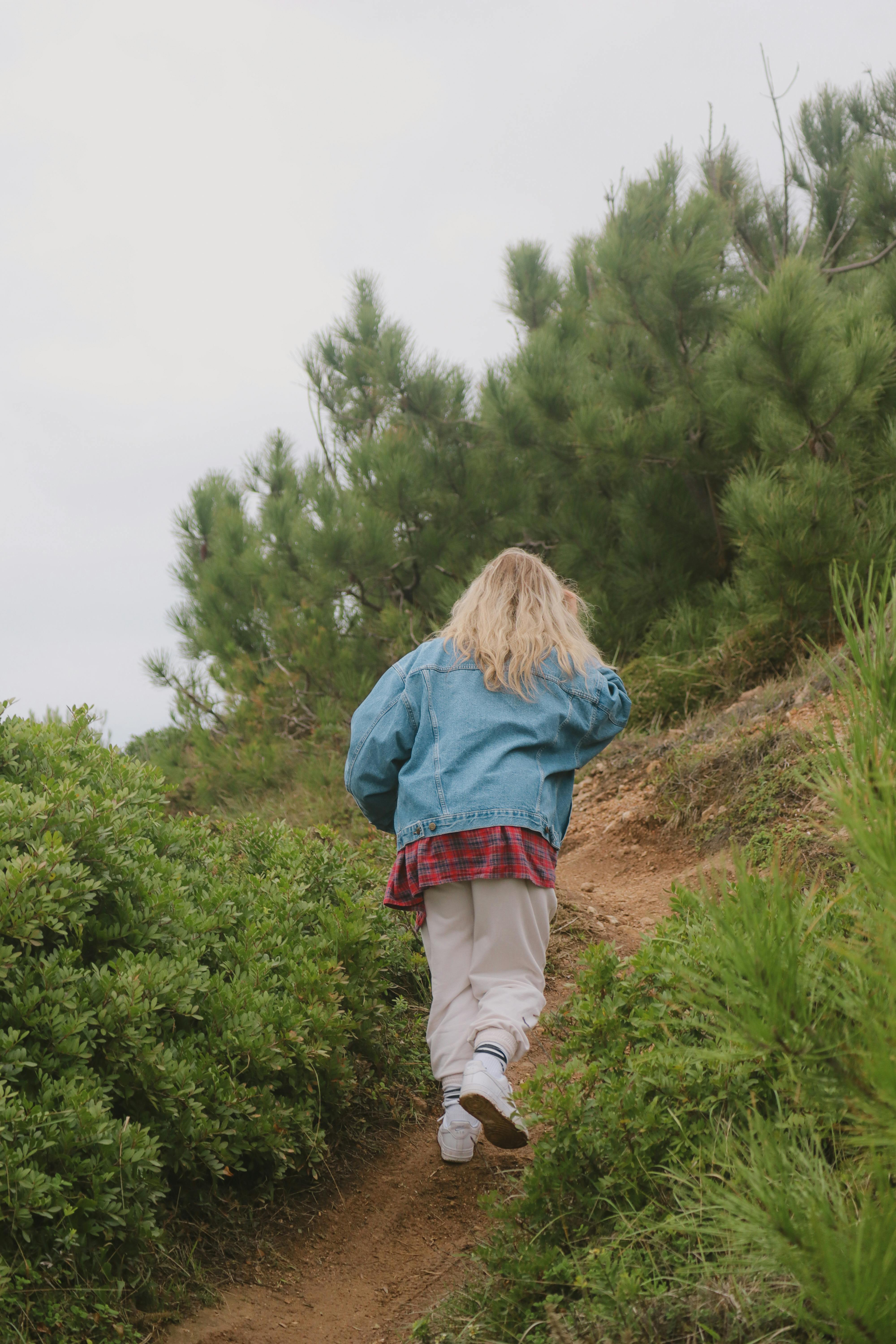 Back View of a Woman Walking Uphill · Free Stock Photo
