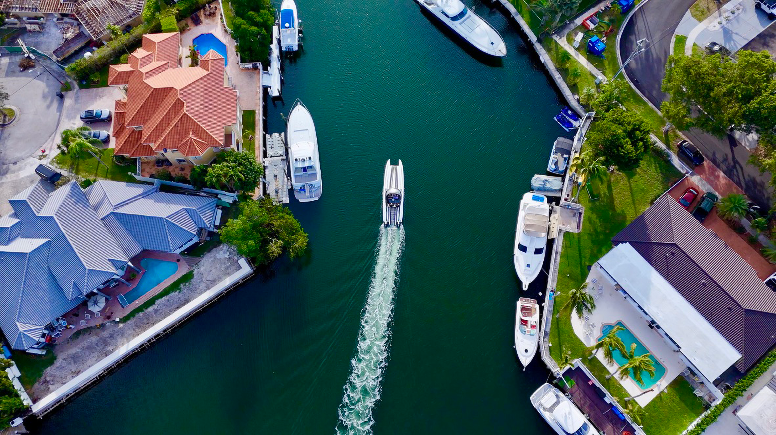 Motor Yachts on Canal in Tropical Town · Free Stock Photo