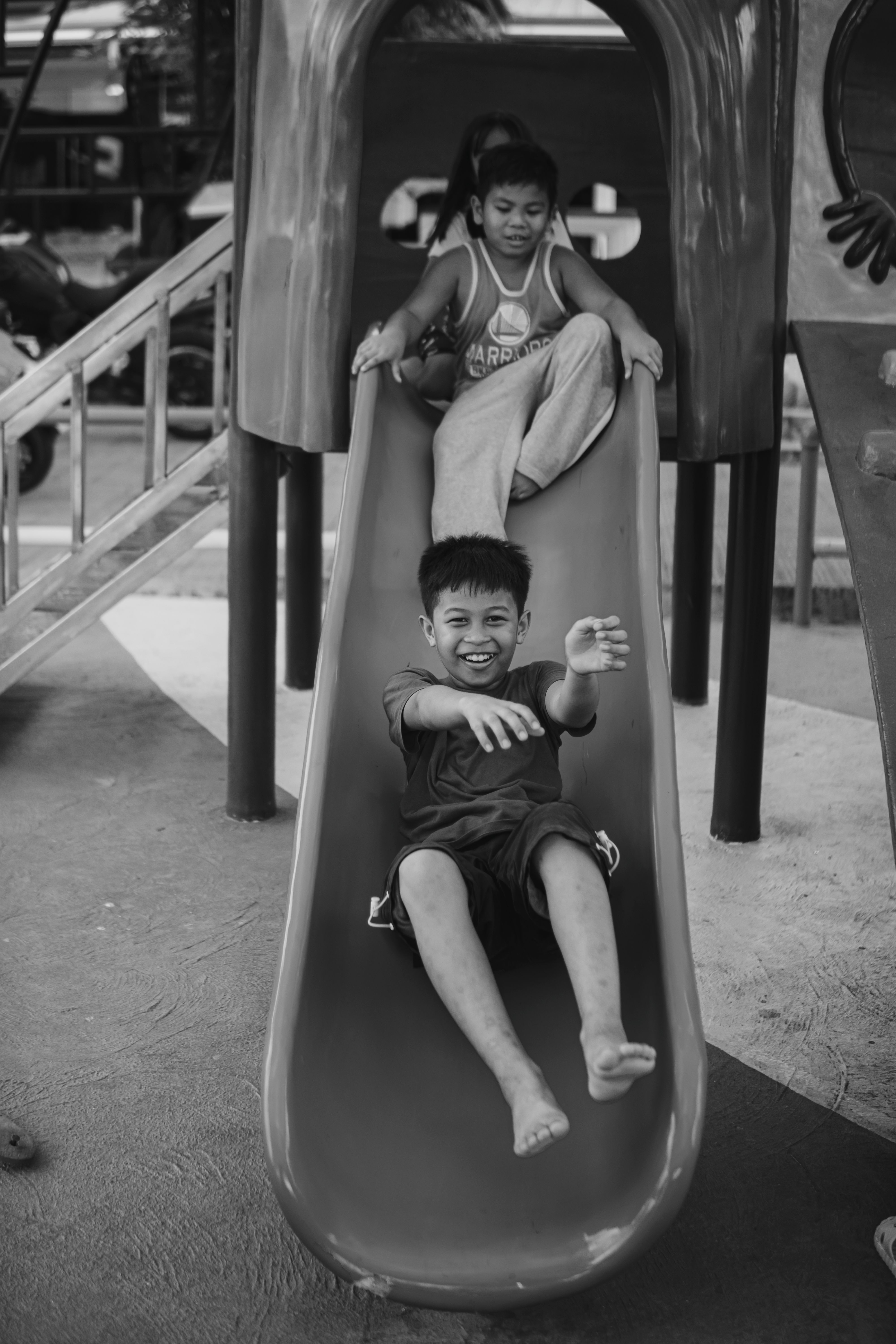 Two children on a slide in a playground · Free Stock Photo