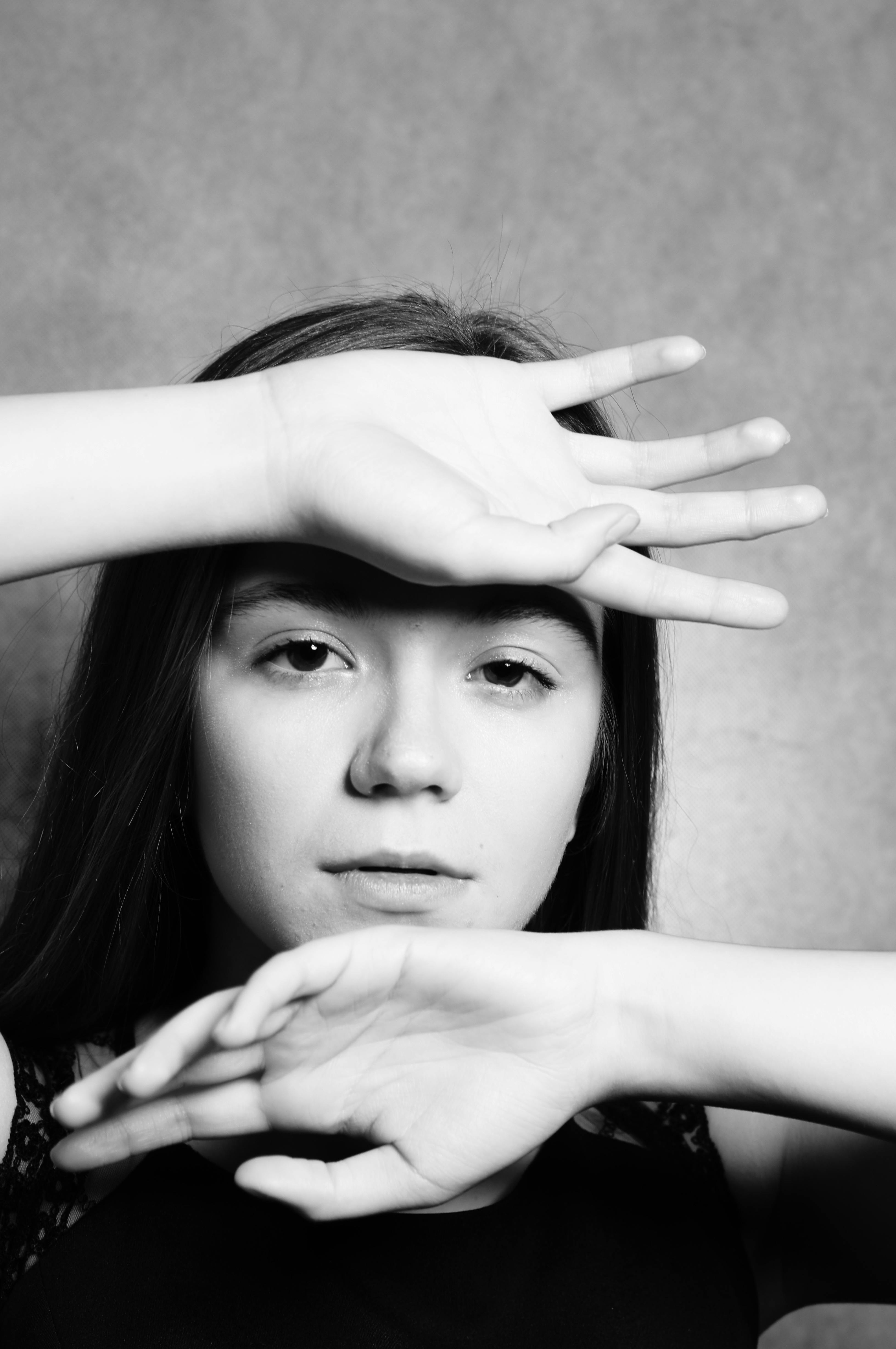 Girl with Hands around Face in Black and White · Free Stock Photo
