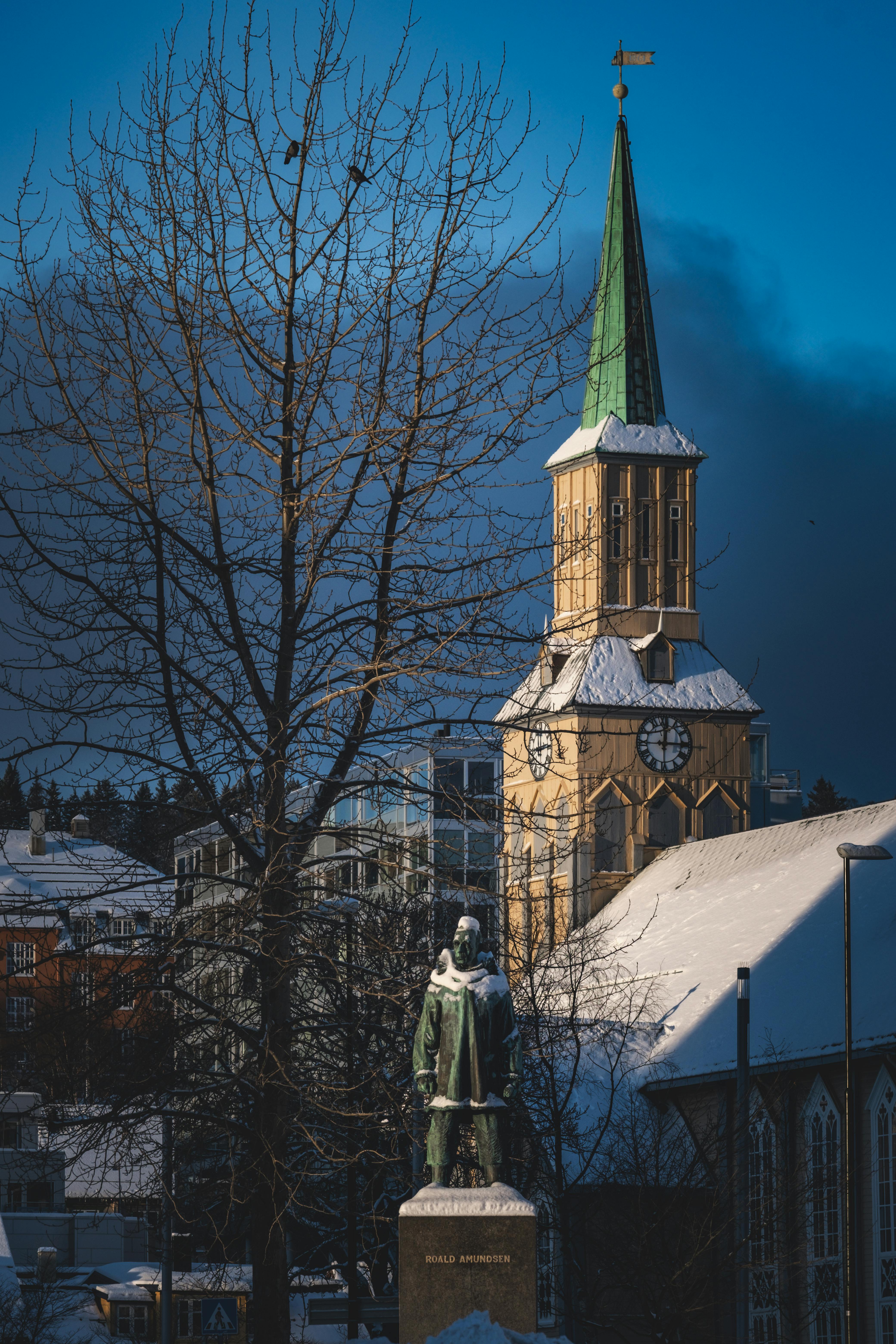 Statue and Church in Town in Winter · Free Stock Photo