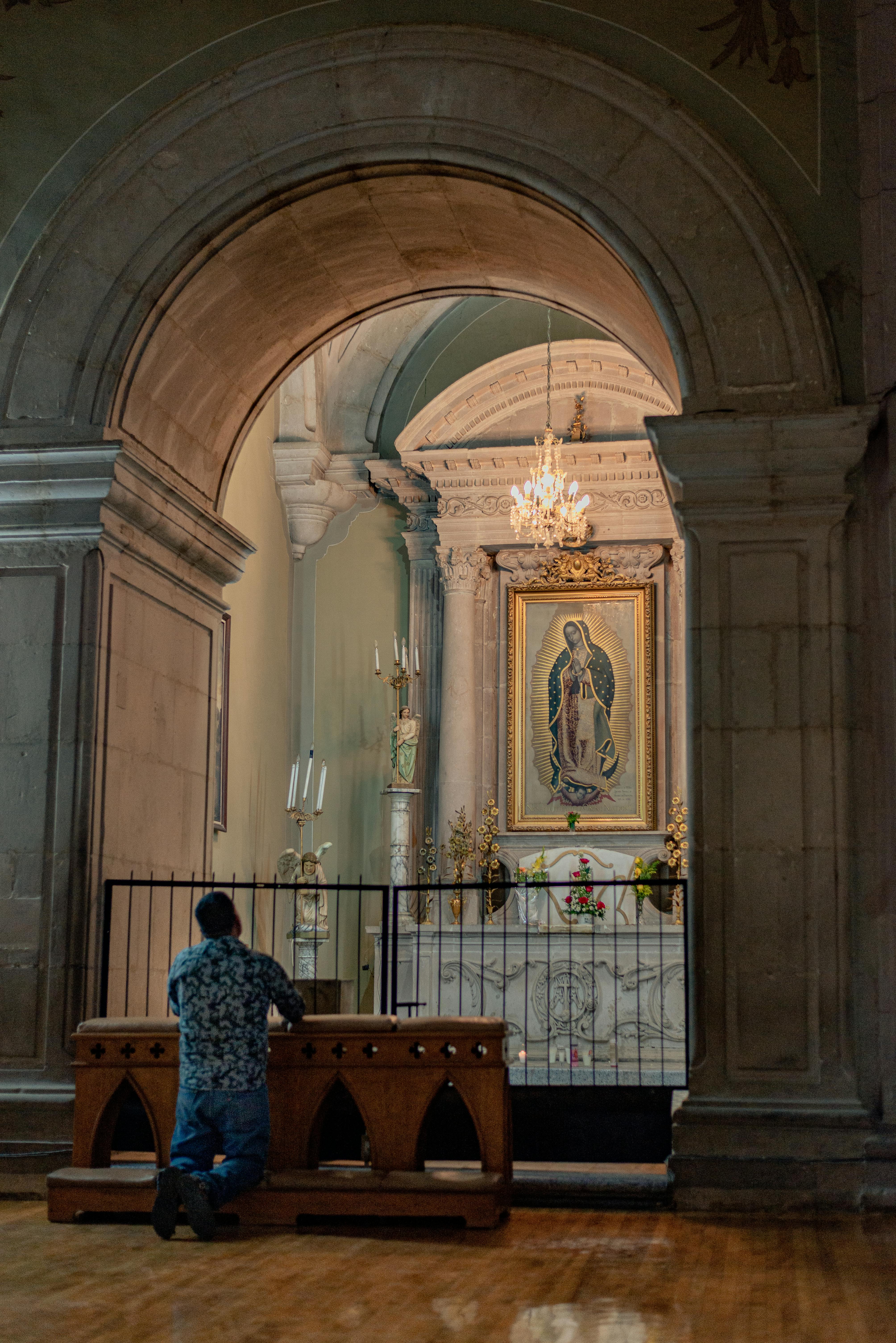 Man Praying to Painting in Church · Free Stock Photo