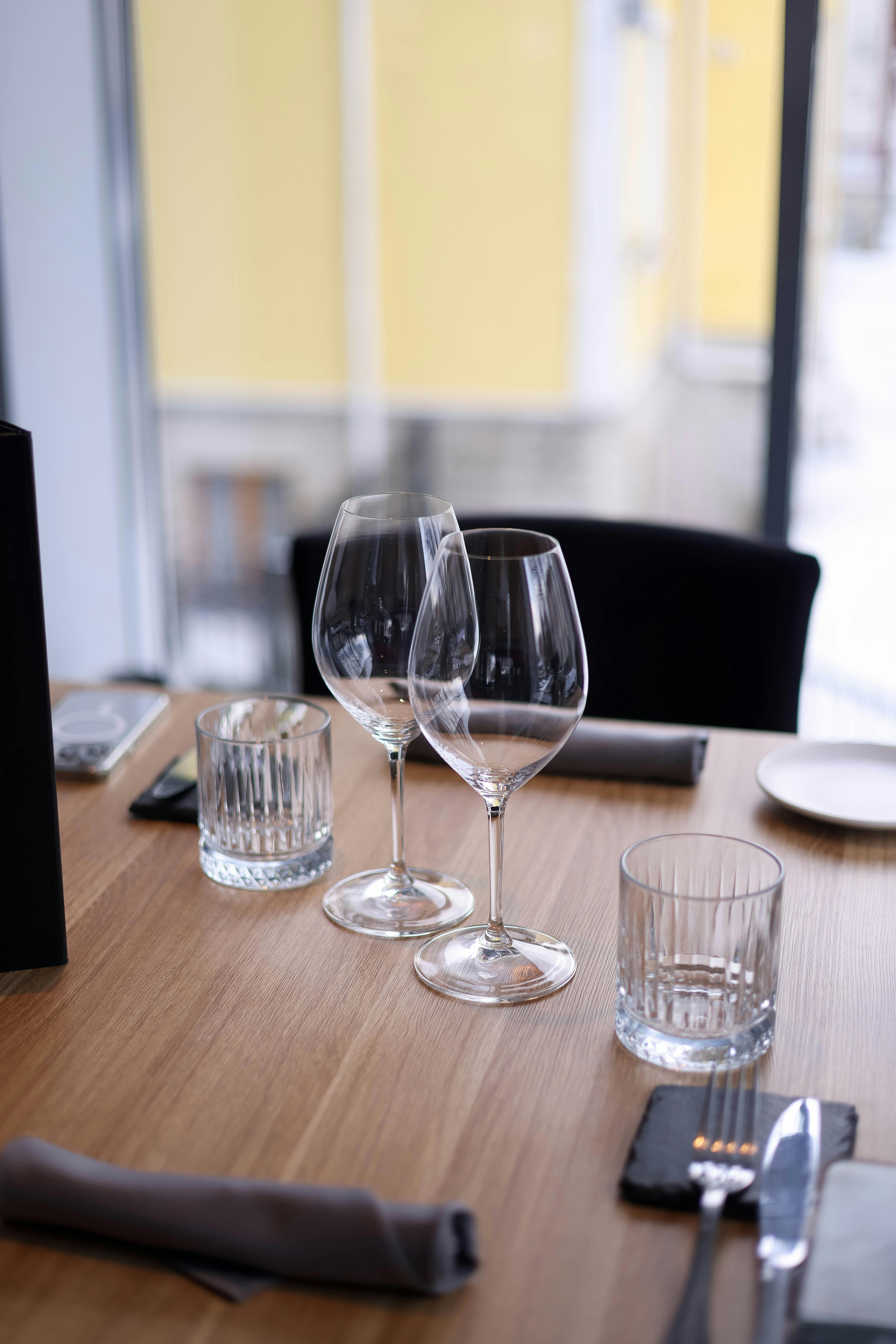 Clear Long-stemmed Wine Glass on Brown Table · Free Stock Photo