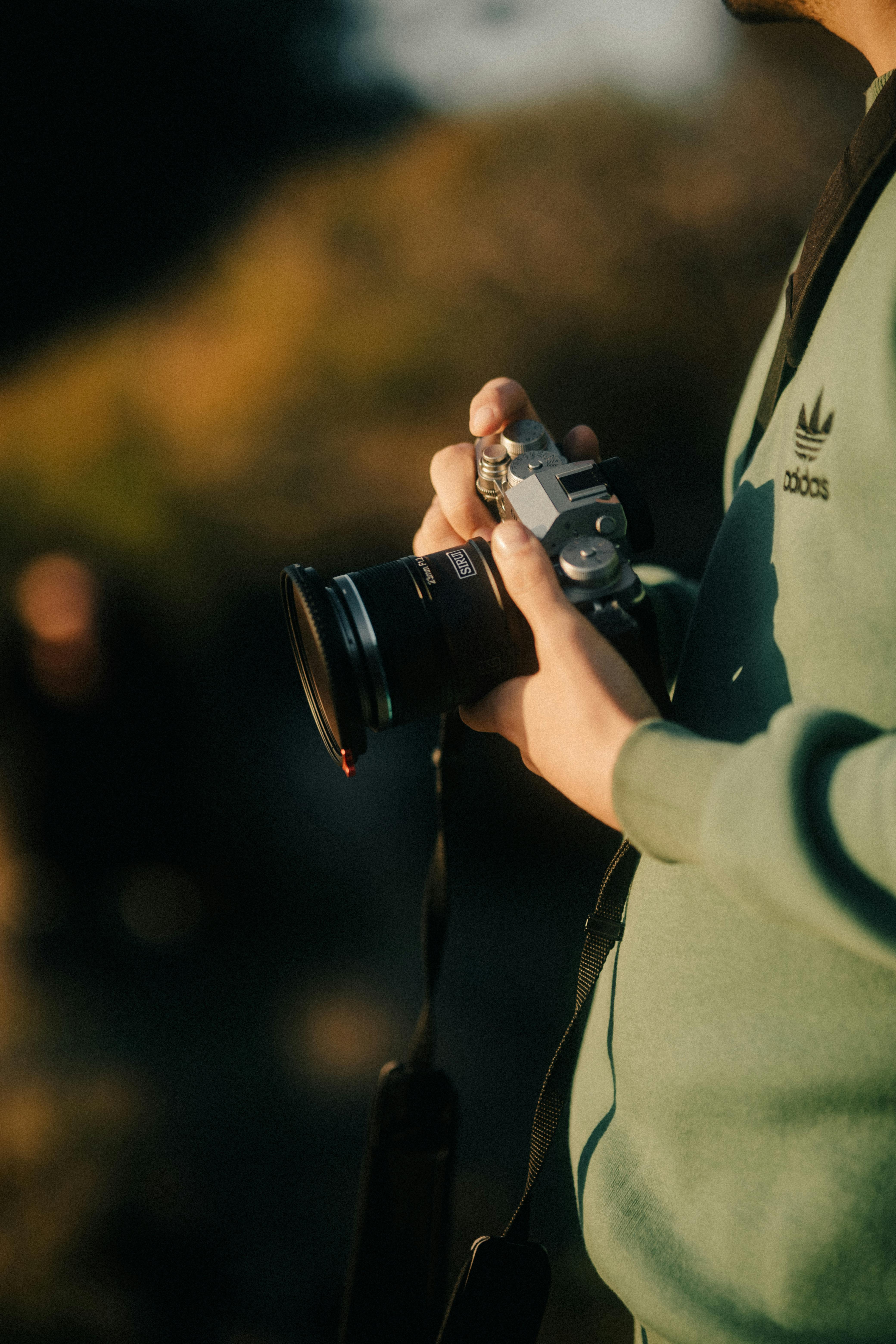 Photography of Man Holding Dslr Camera · Free Stock Photo