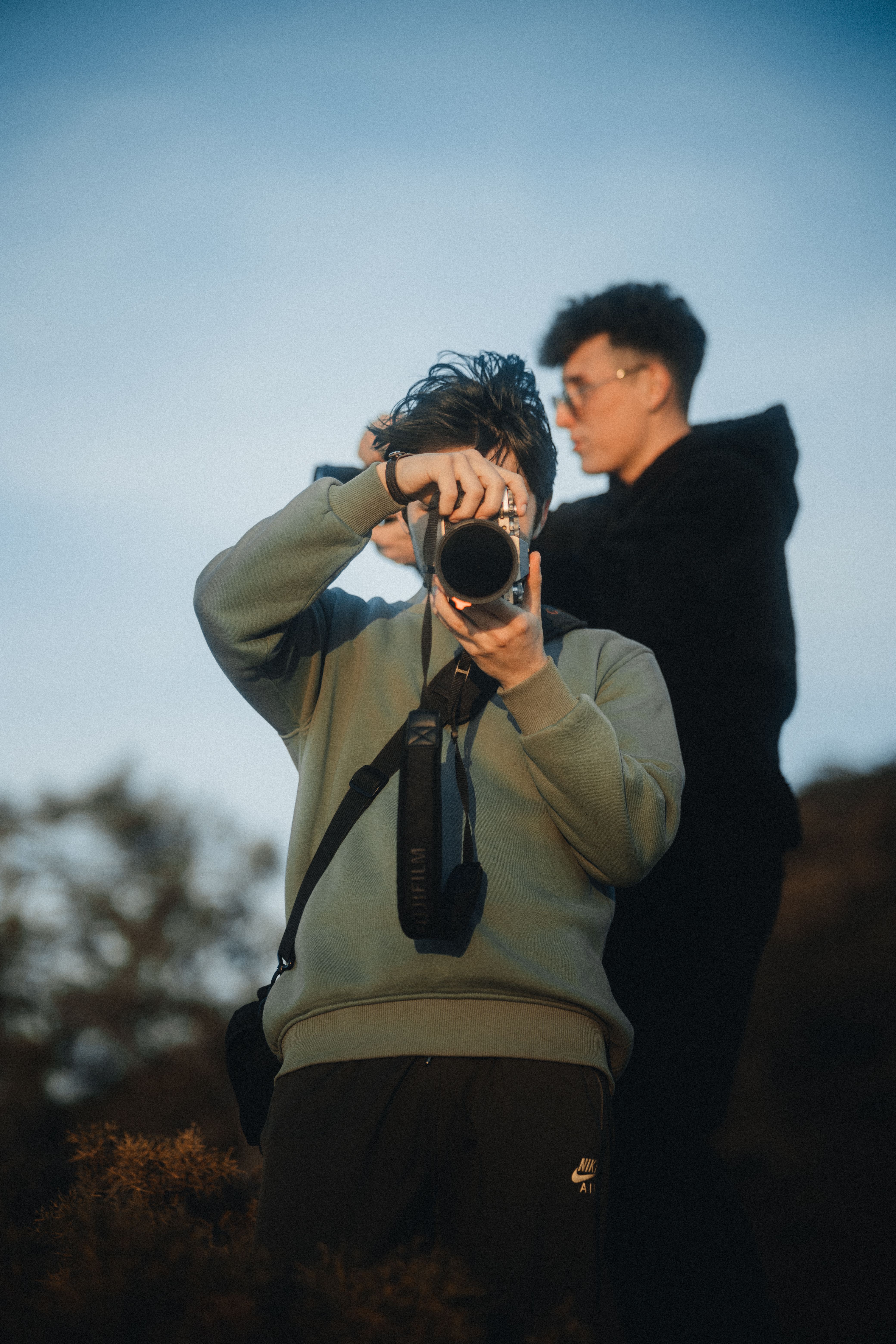Two people taking pictures with a camera · Free Stock Photo