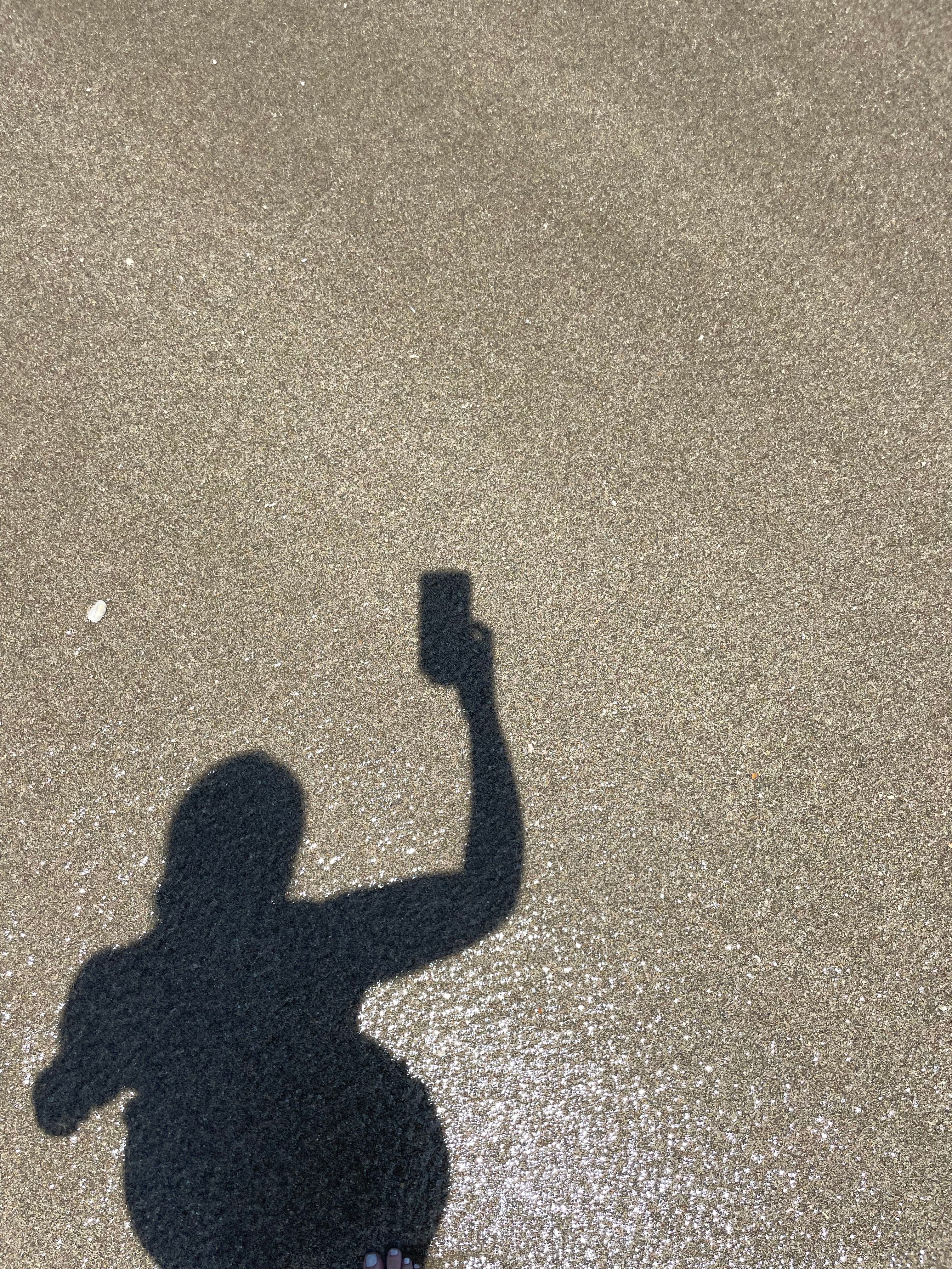 A Person Taking a Picture of Their Shadow · Free Stock Photo