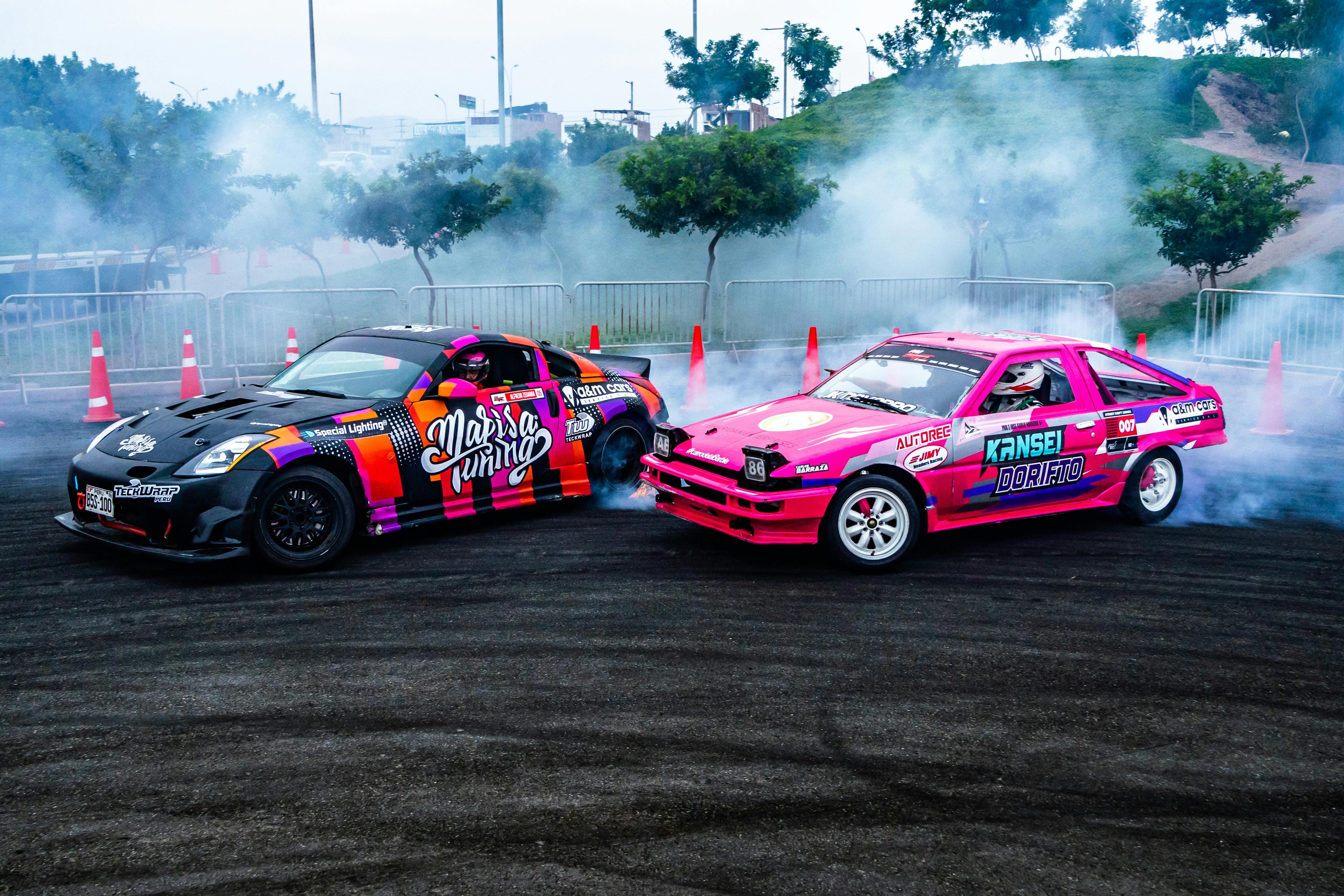 Pink and Black Racing Cars on the Field · Free Stock Photo