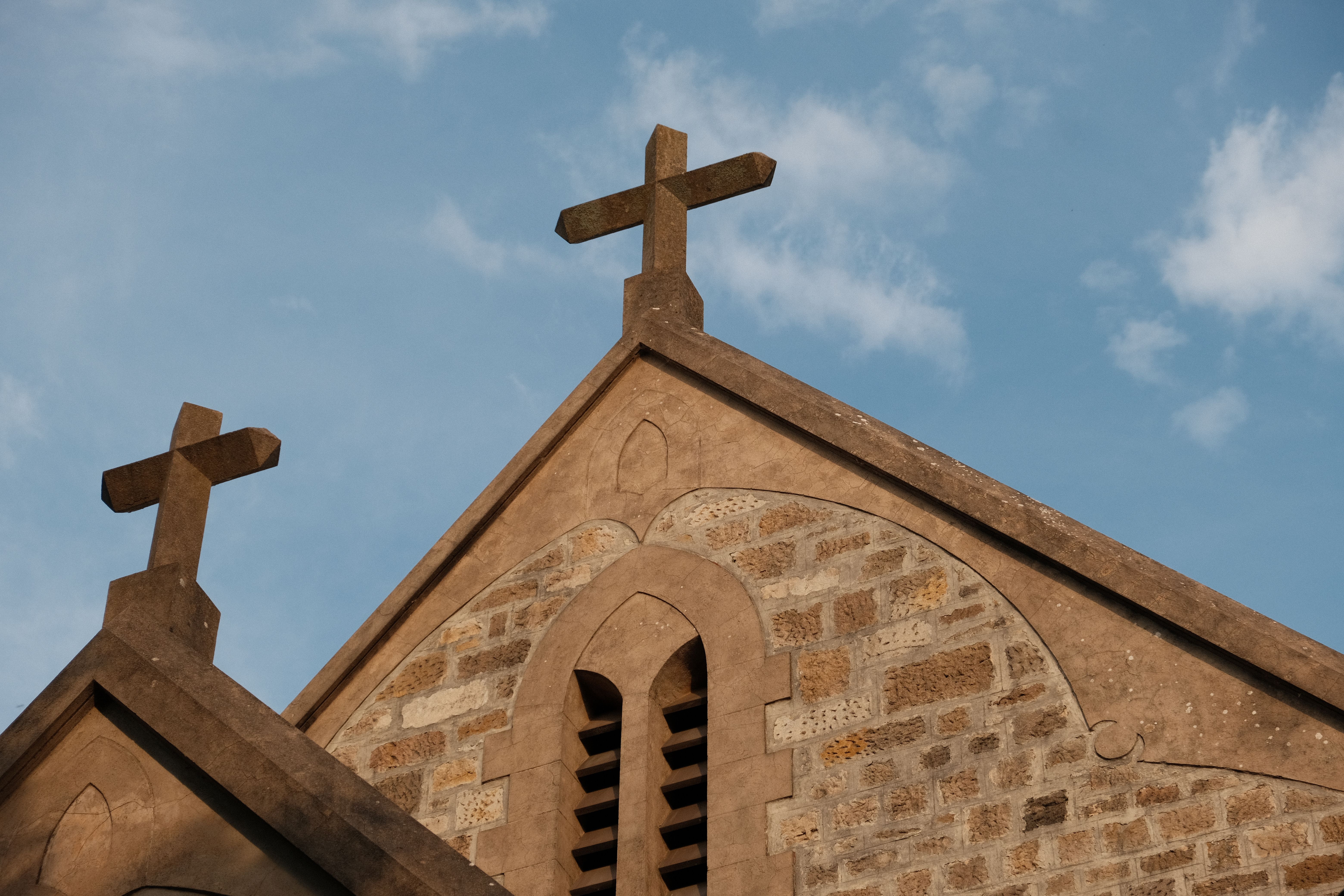 Two crosses on top of a church building · Free Stock Photo