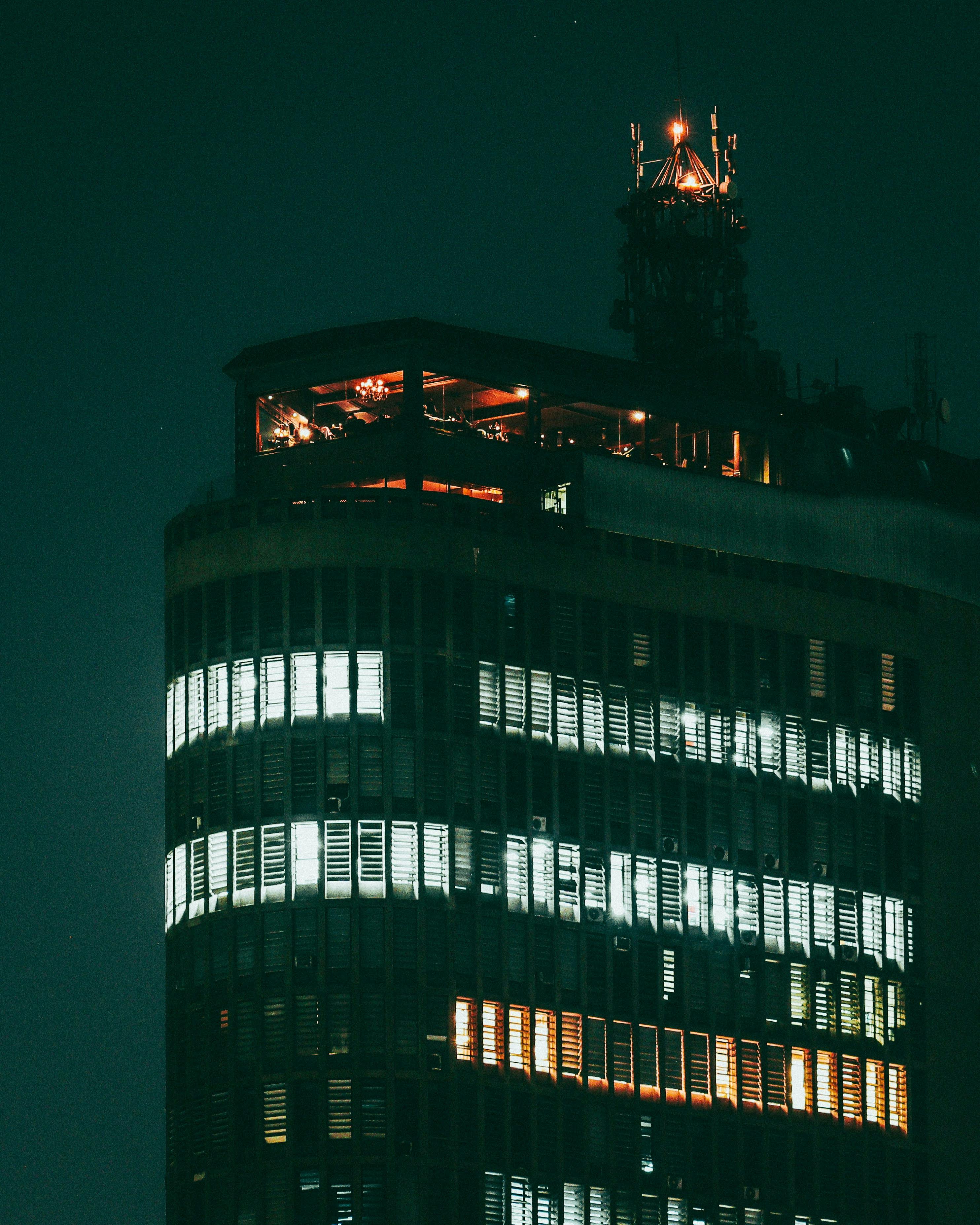 Illuminated Modern Skyscraper with Antenna on Top · Free Stock Photo