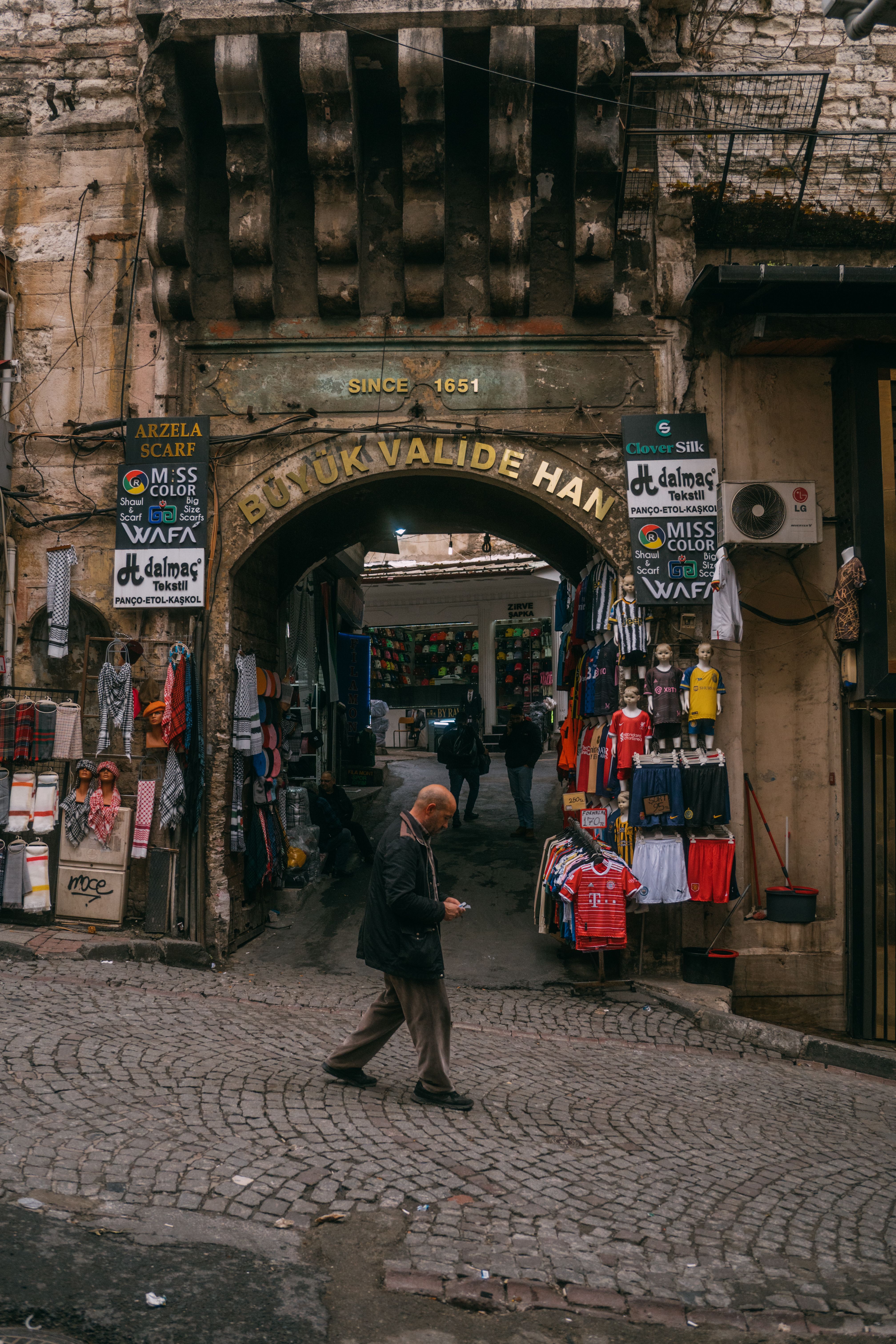 A Pedestrian Walking Past the Entrance of the Buyuk Valide Han in ...