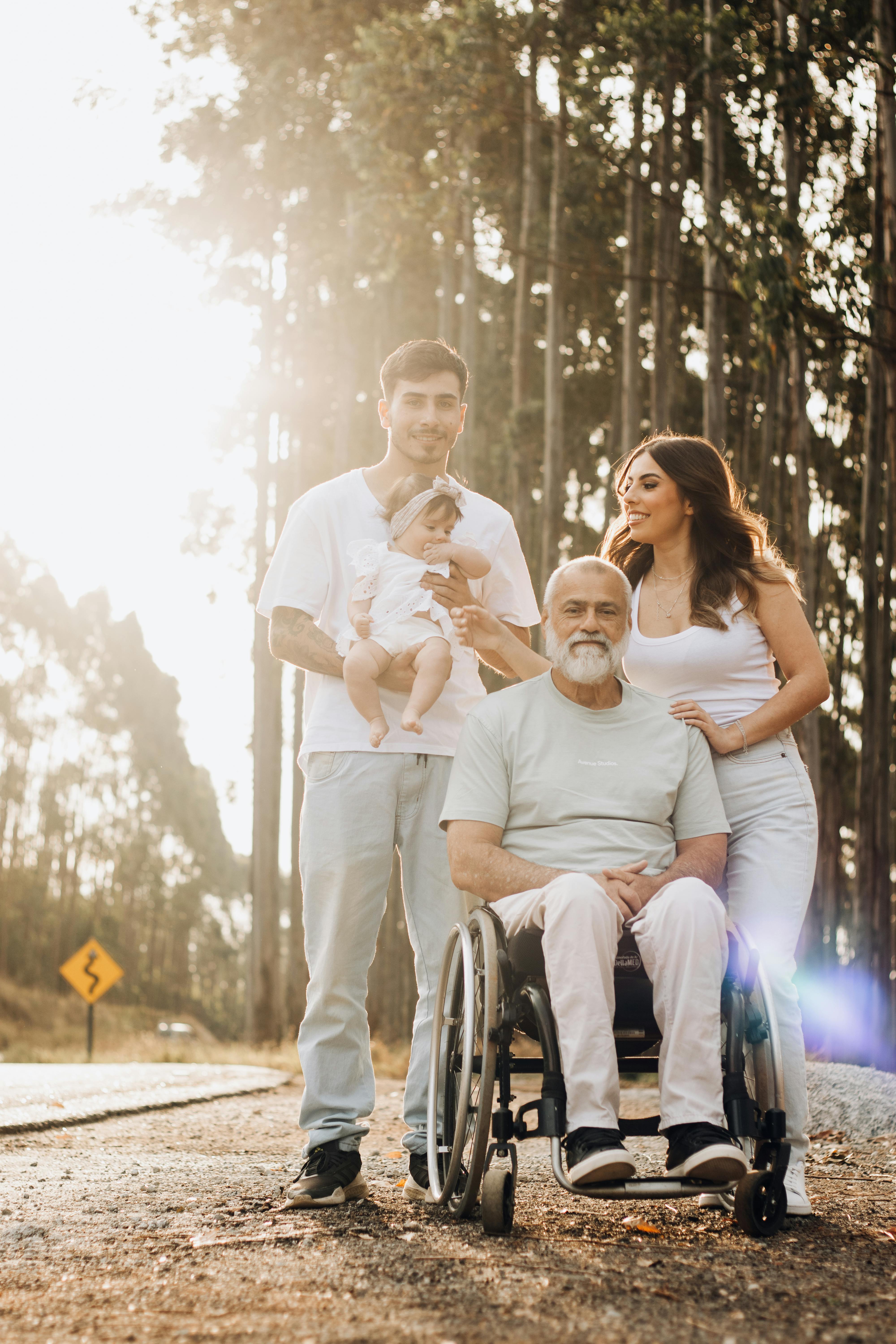 A family poses for a photo in a wheelchair · Free Stock Photo