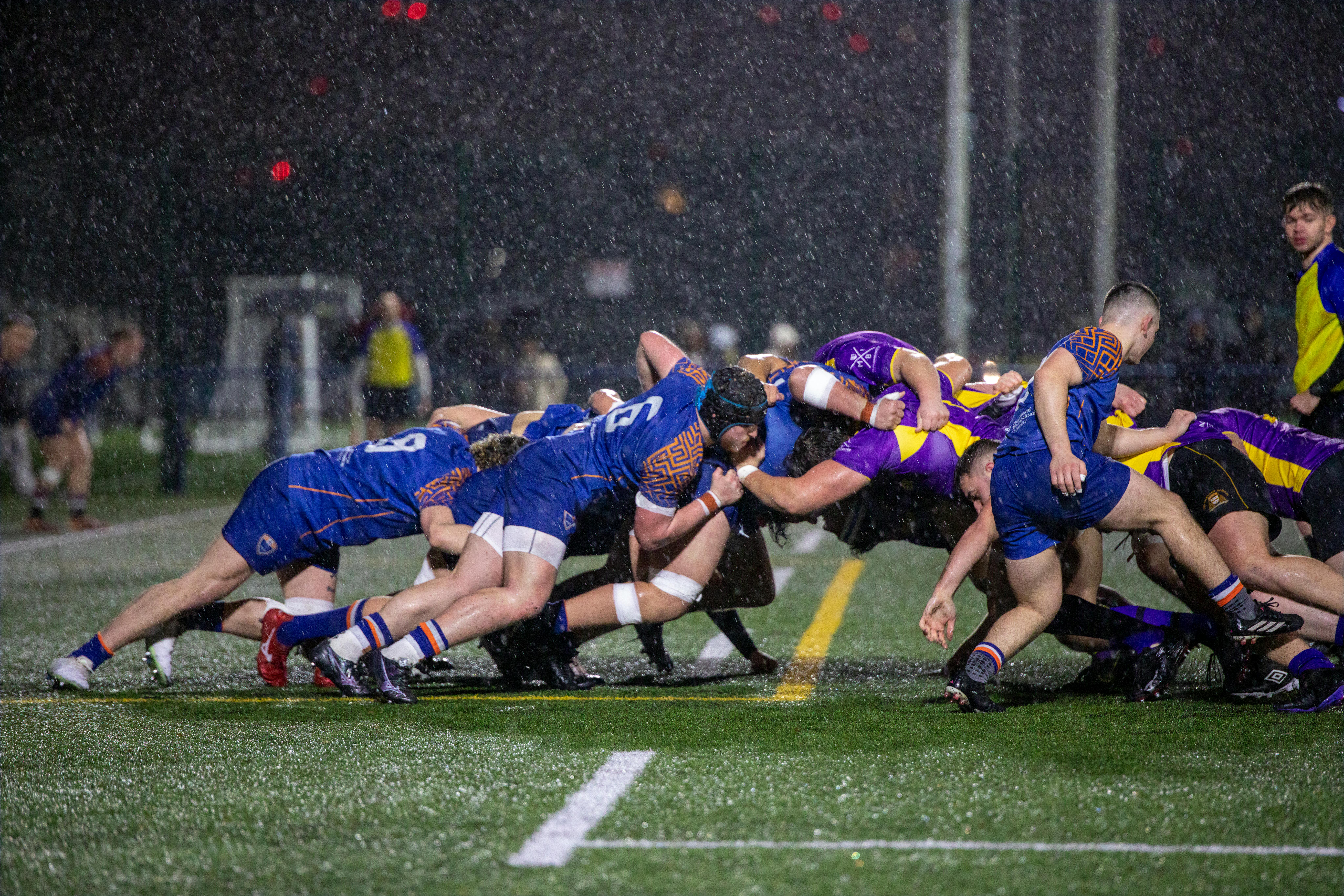 Rugby Players in Scrum Formation in Rain · Free Stock Photo