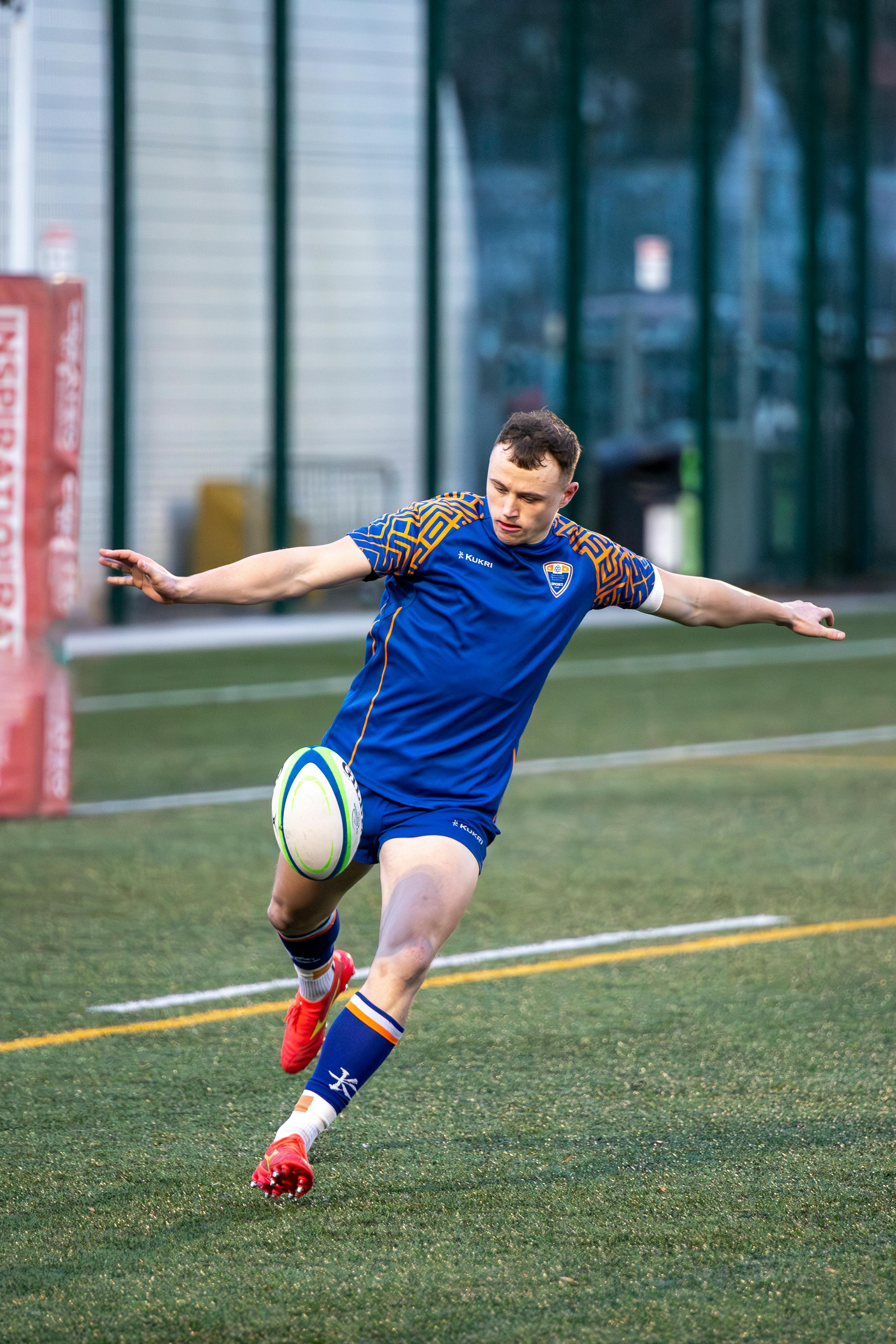 Rugby Player Kicking a Ball · Free Stock Photo