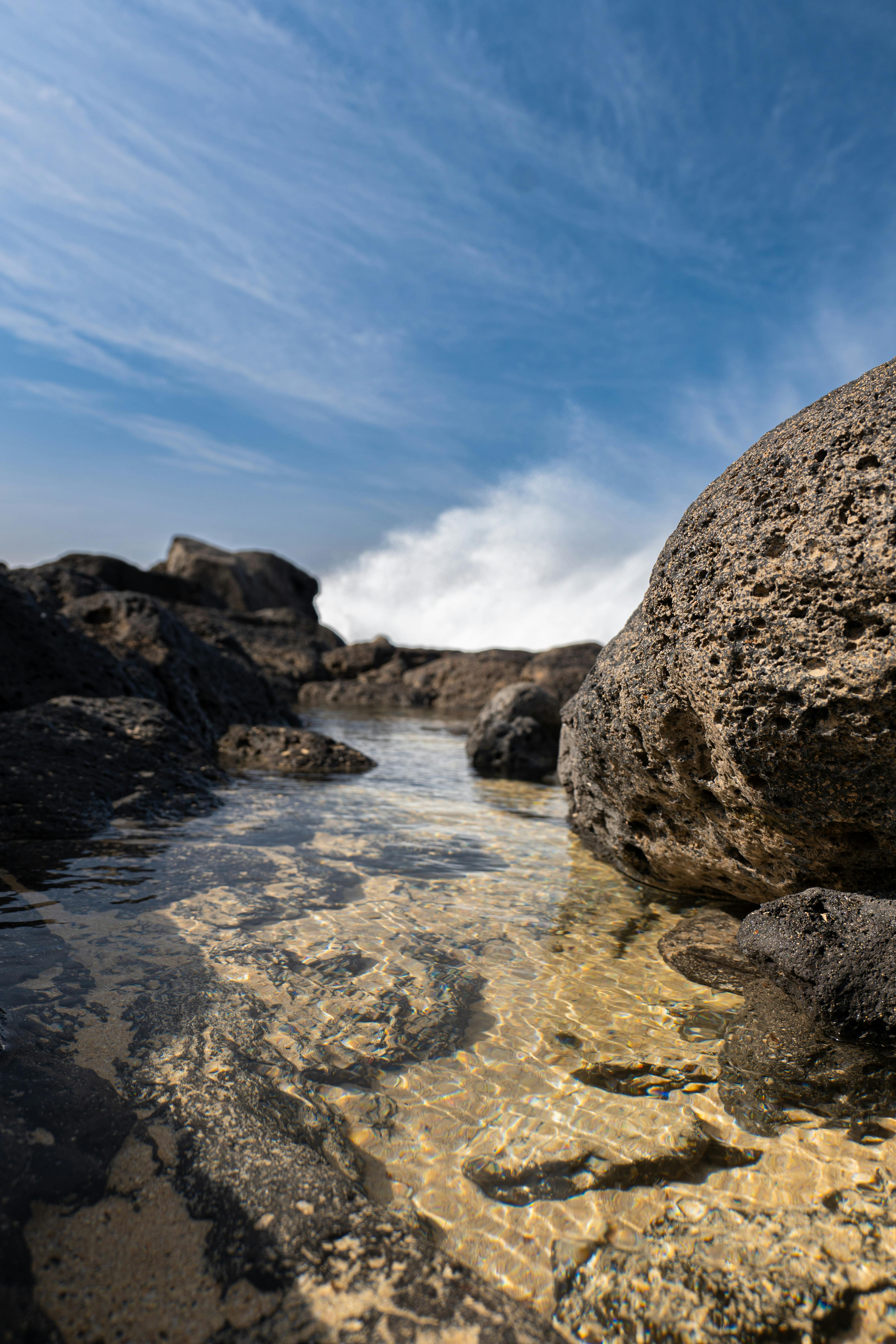 Rocks in Shallow Water on Sea Shore · Free Stock Photo