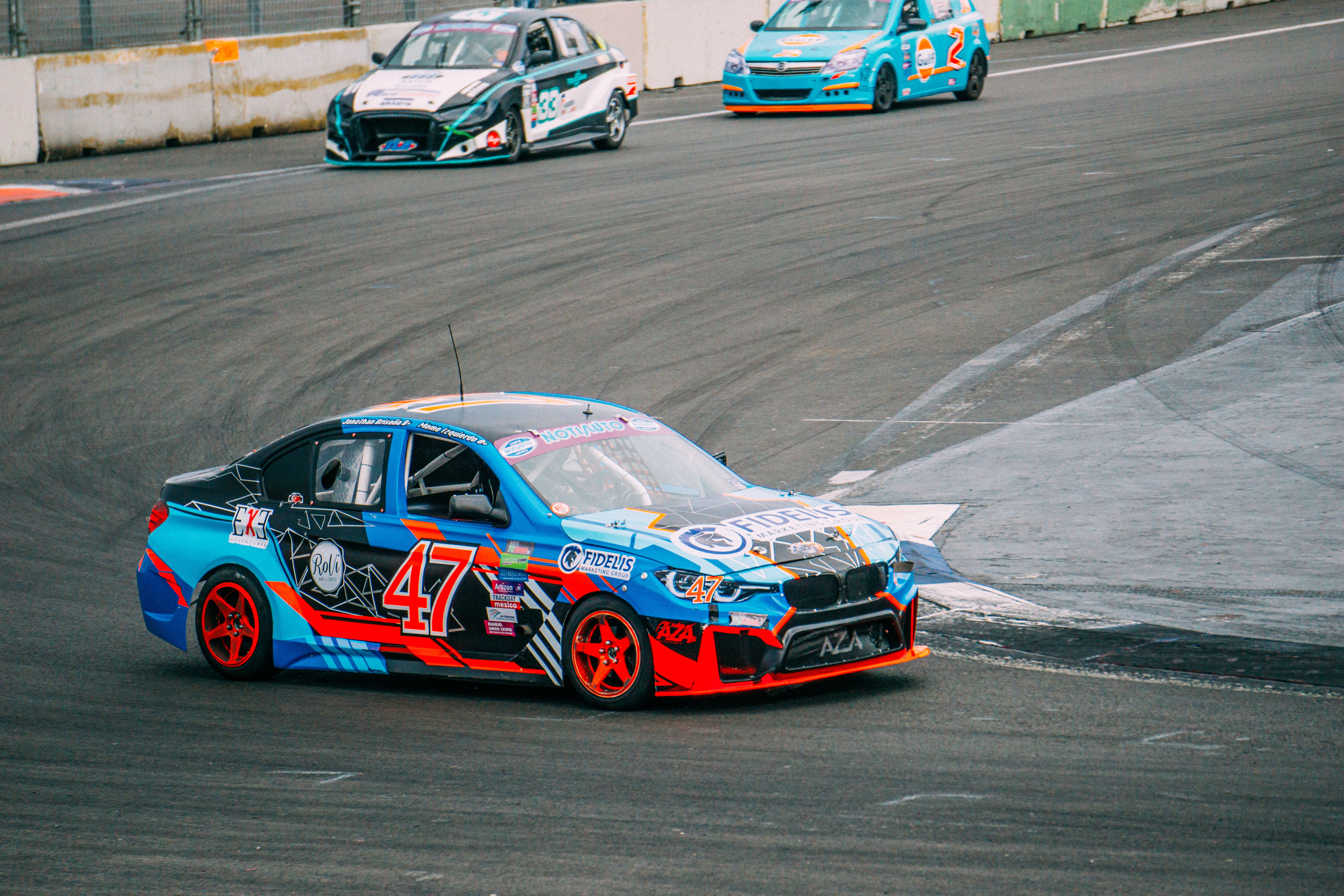 Cars Racing on a Track · Free Stock Photo