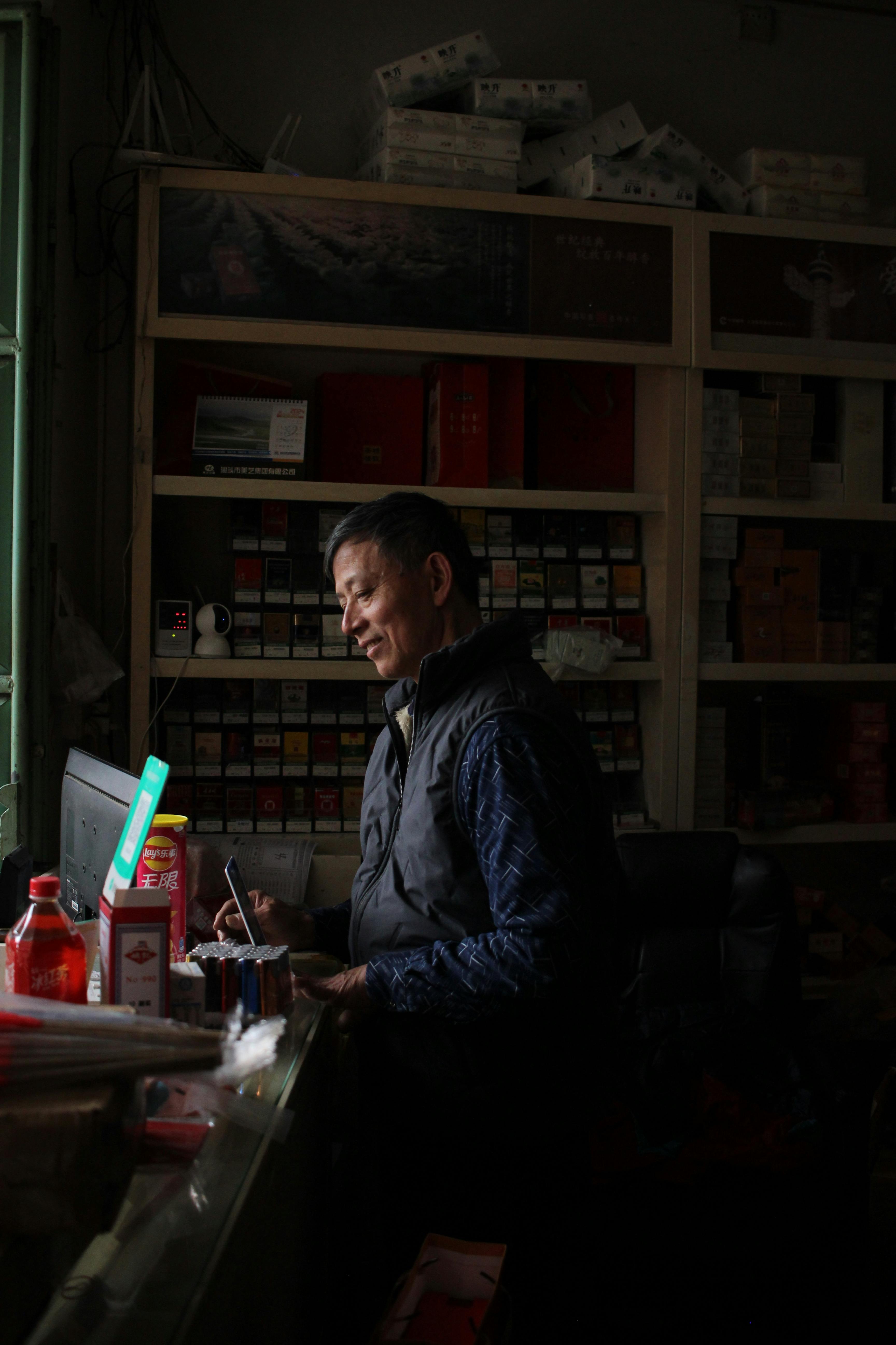 Merchant in Dark Store · Free Stock Photo