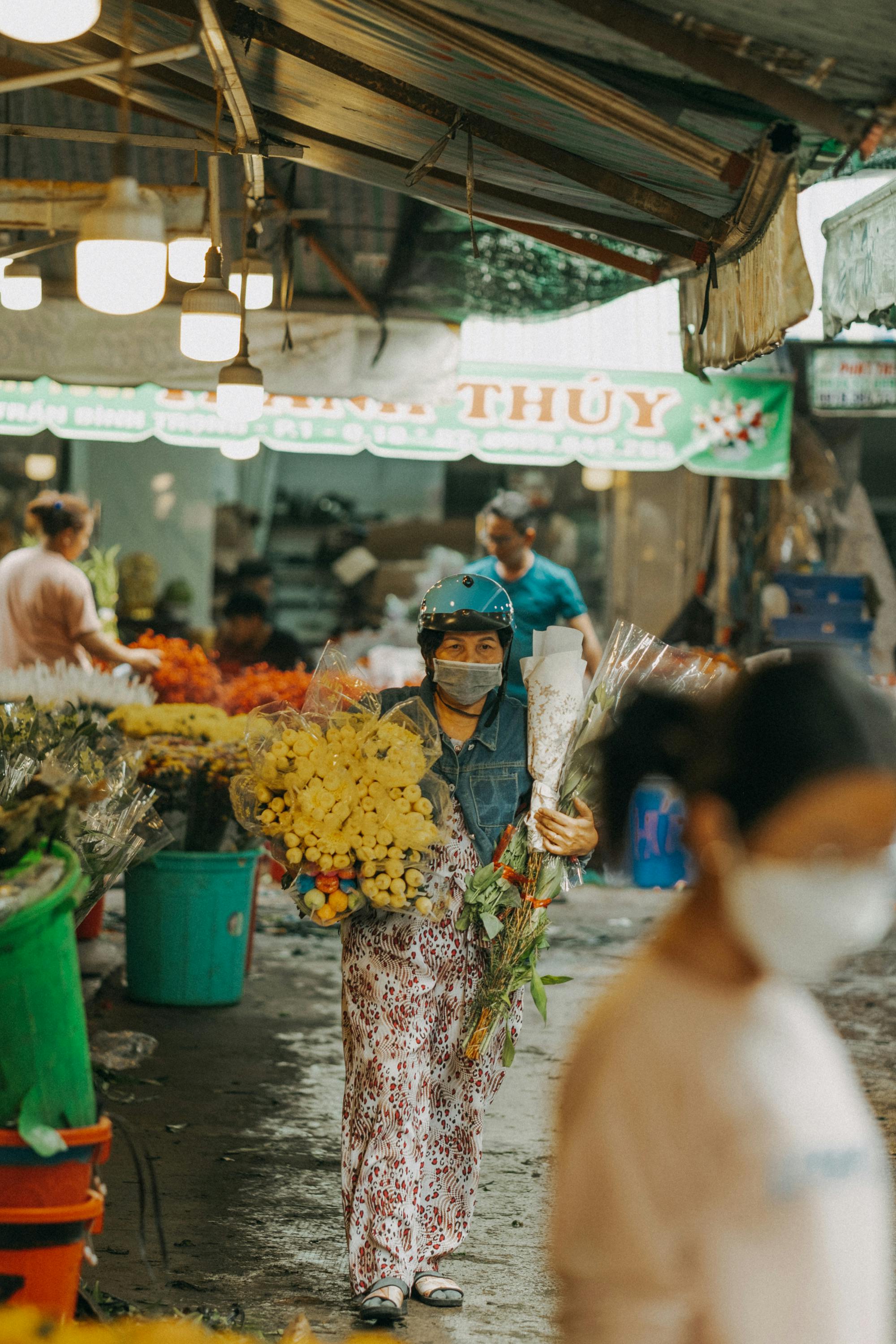 Woman Walking with Flowers at Bazaar · Free Stock Photo