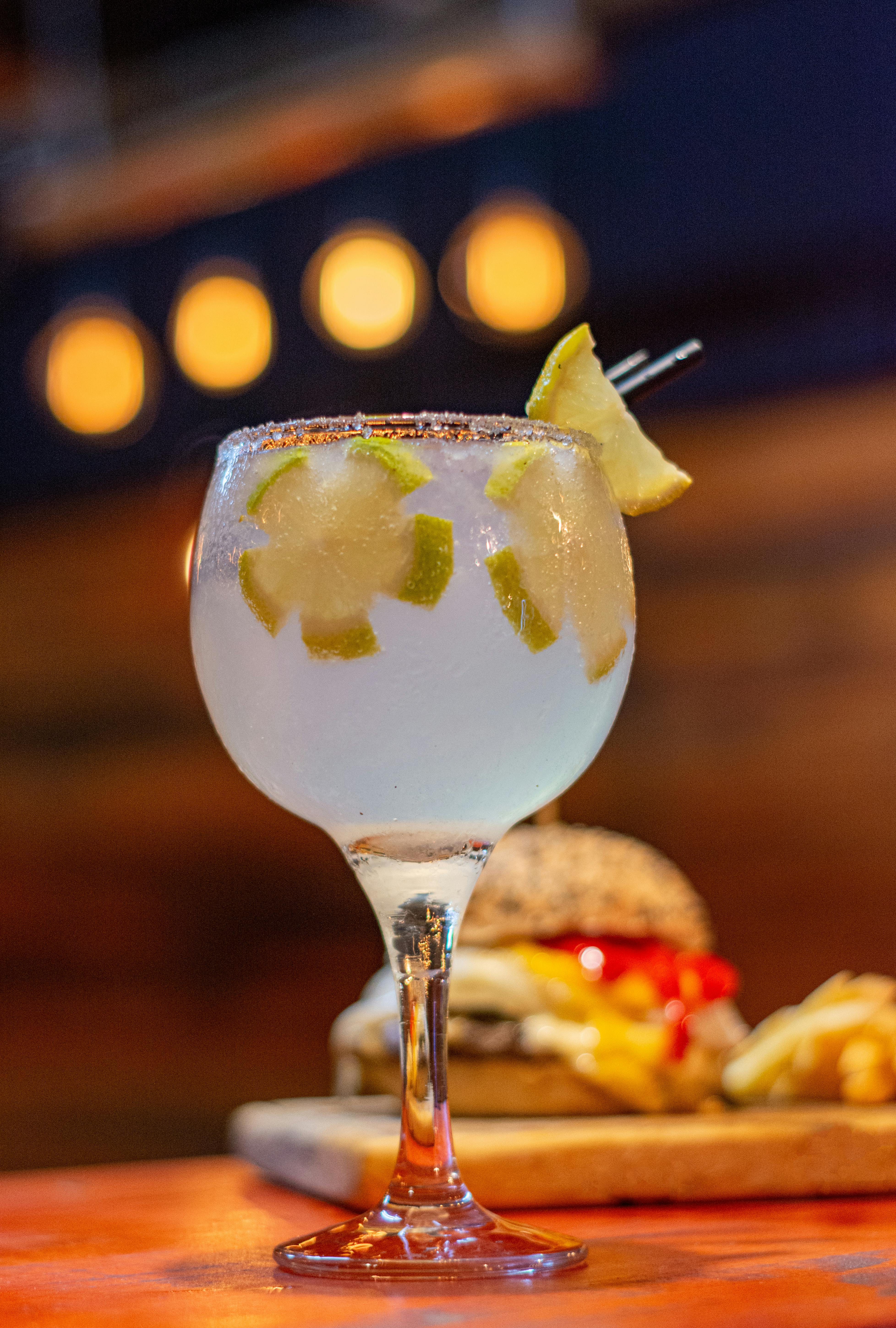 White Cocktail with Lime Slices and Spiced Rim of Wineglass · Free ...