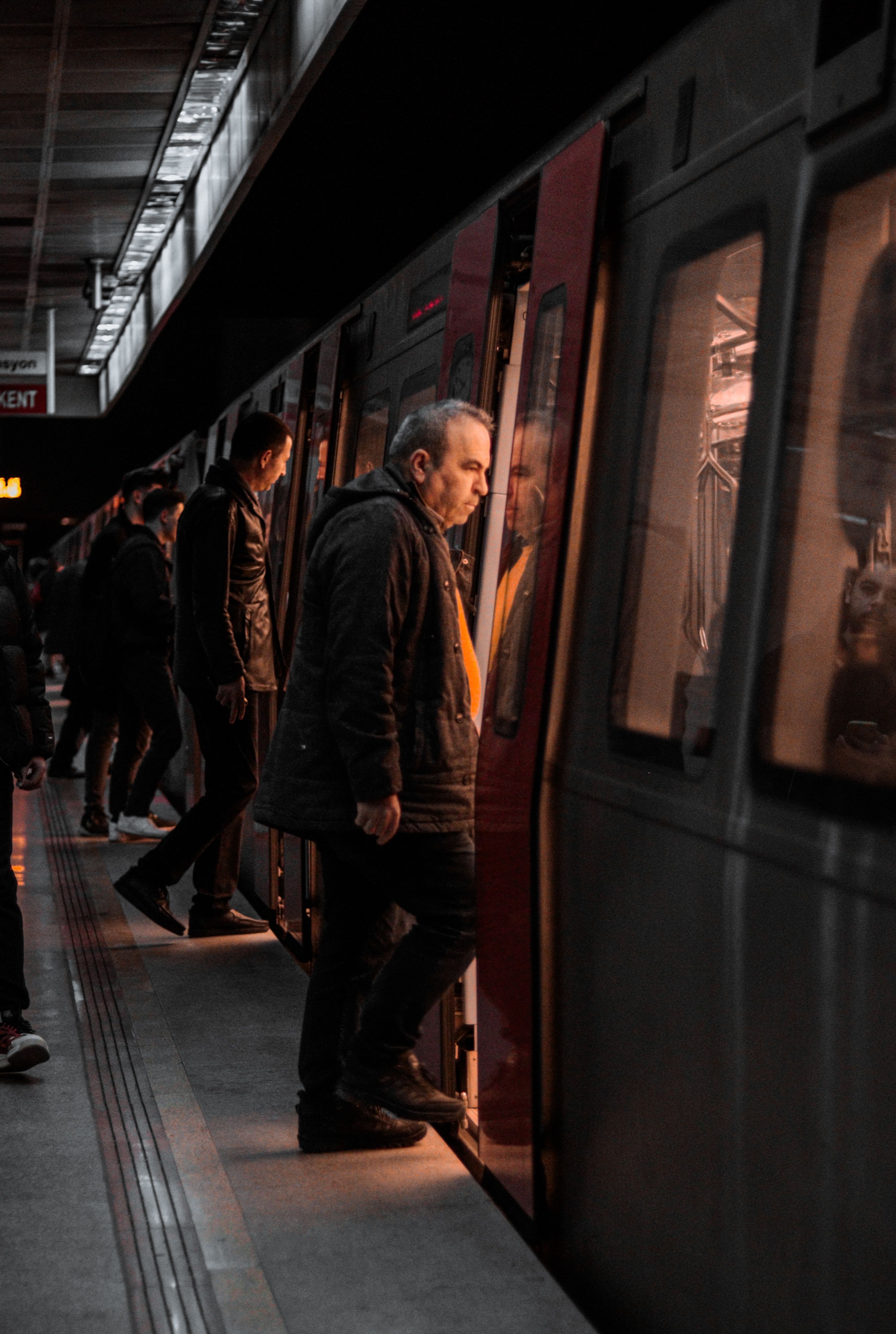 Elderly Man Getting on the Train at the Station · Free Stock Photo