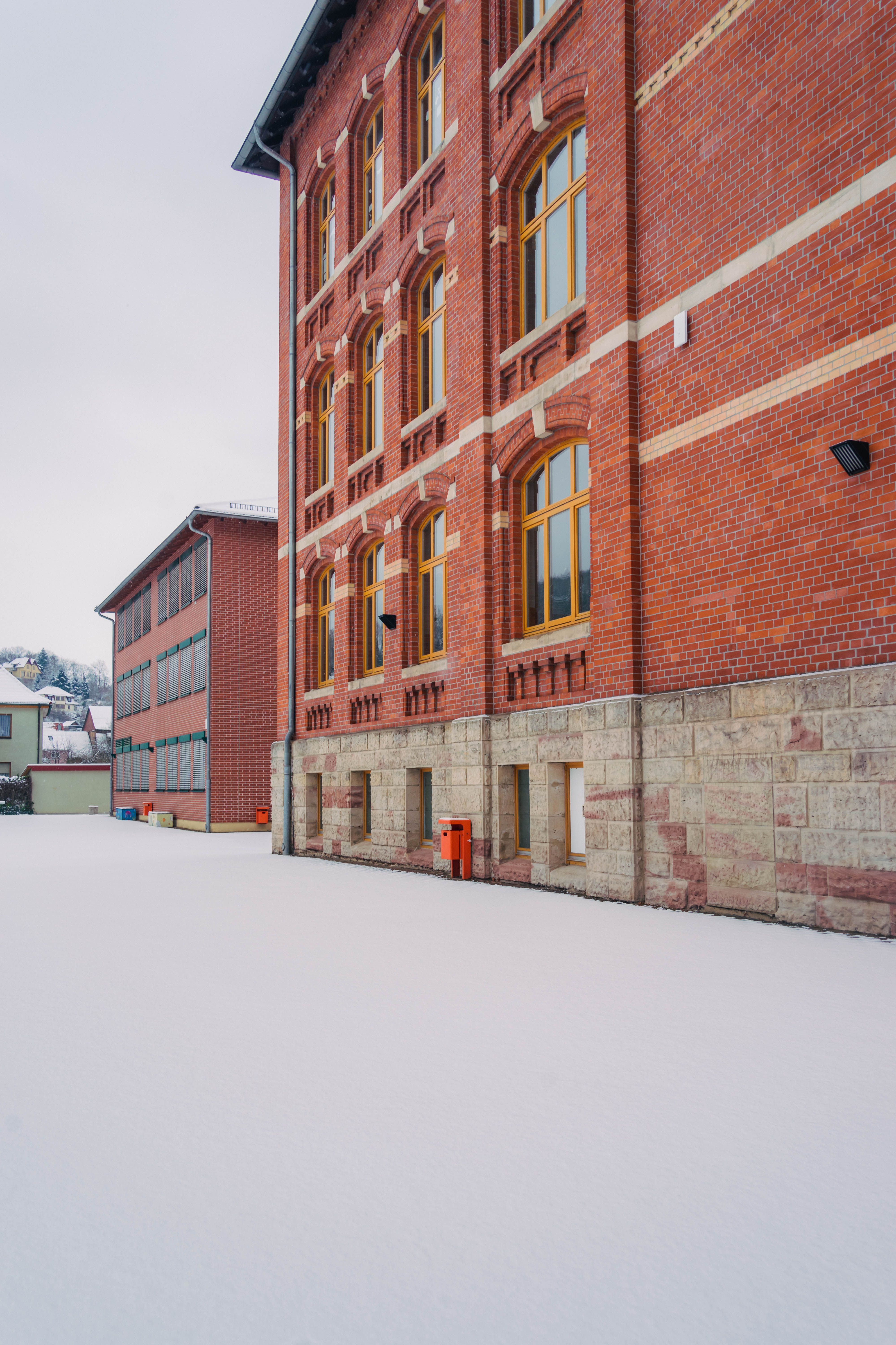 Snow on Pavement by Bricks Buildings · Free Stock Photo