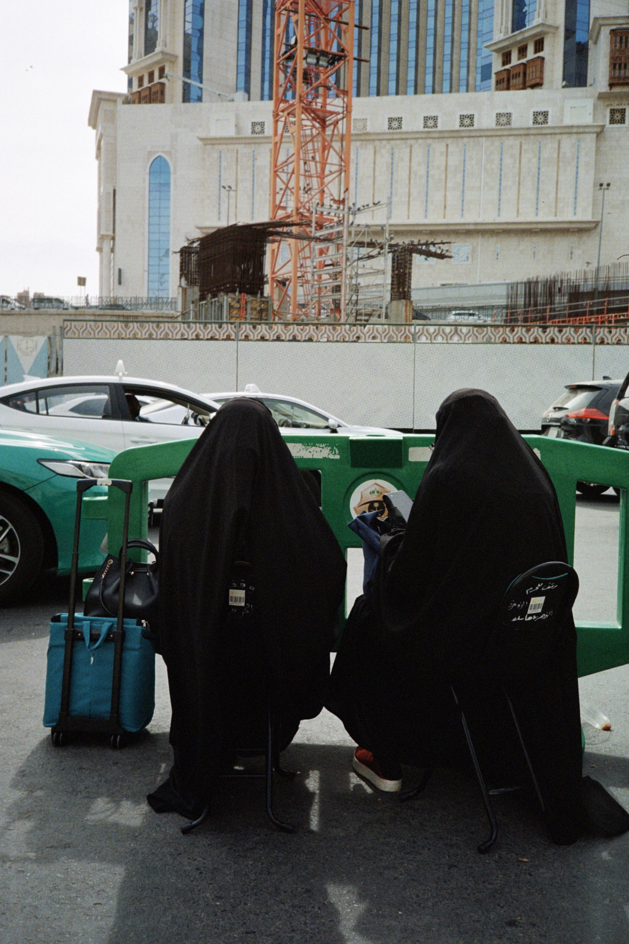 Women in Burkas Sitting next to a Street · Free Stock Photo