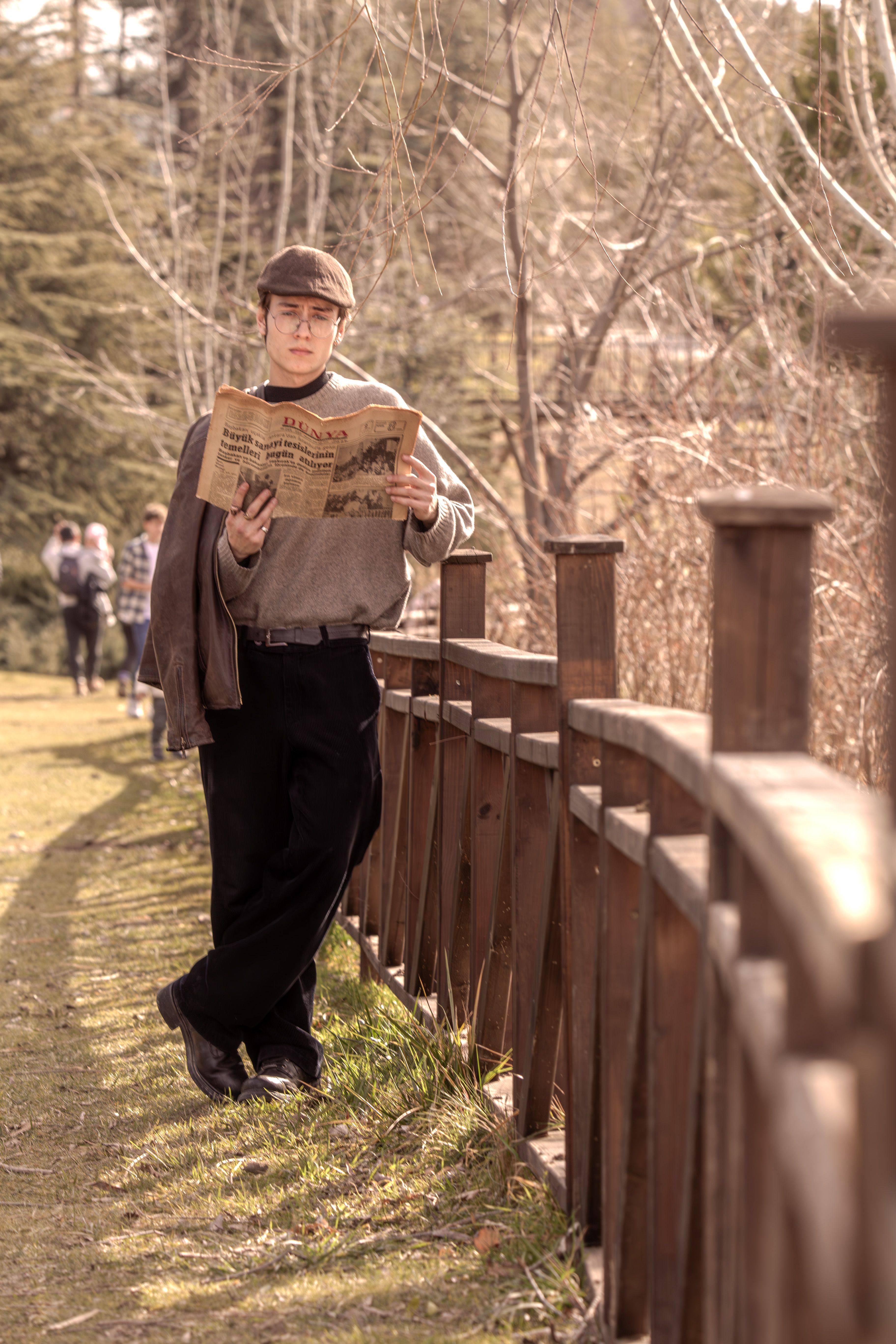 Man in Ivy Cap Standing with Newspaper by Railing in Forest · Free ...