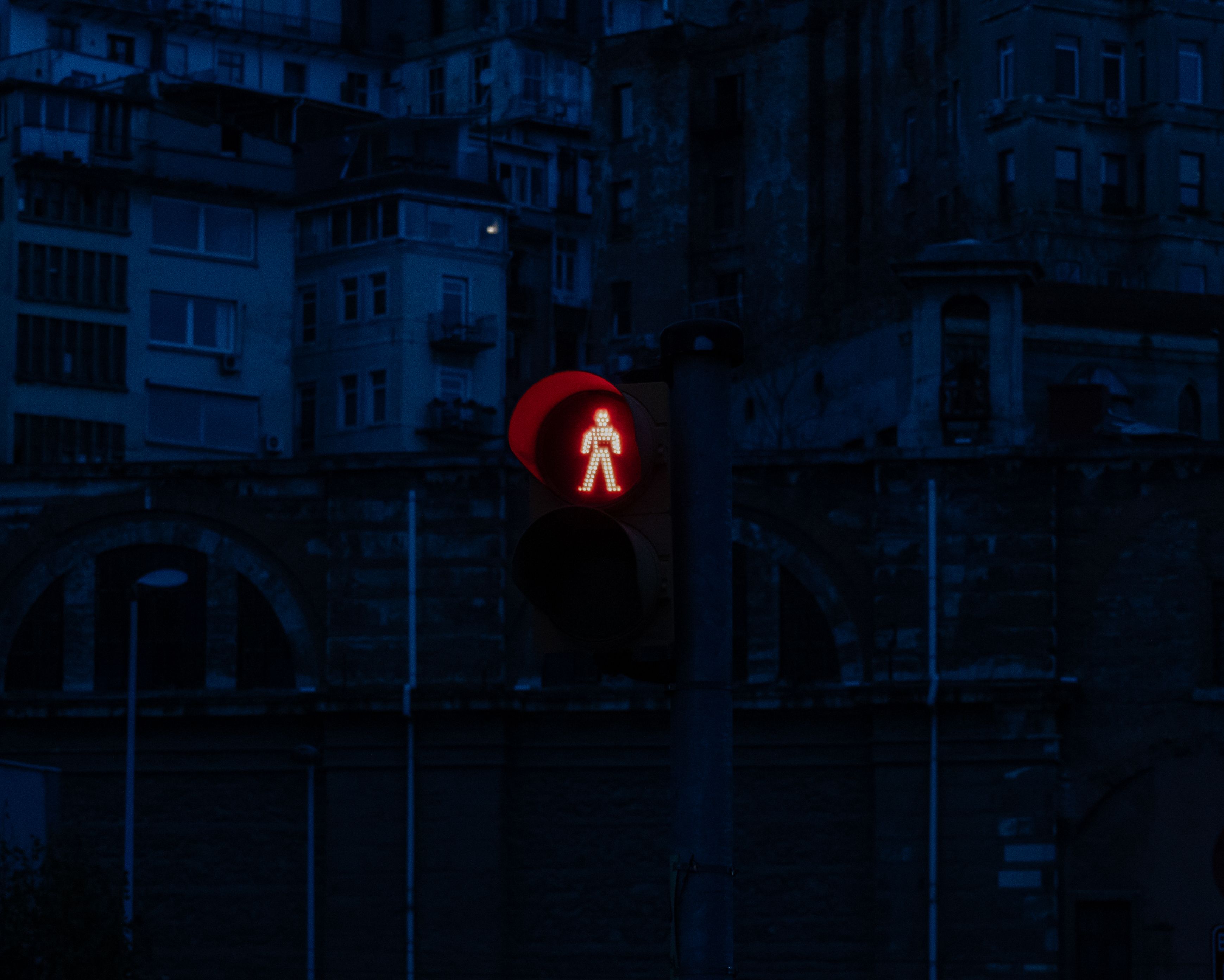 A red traffic light with a pedestrian crossing sign · Free Stock Photo