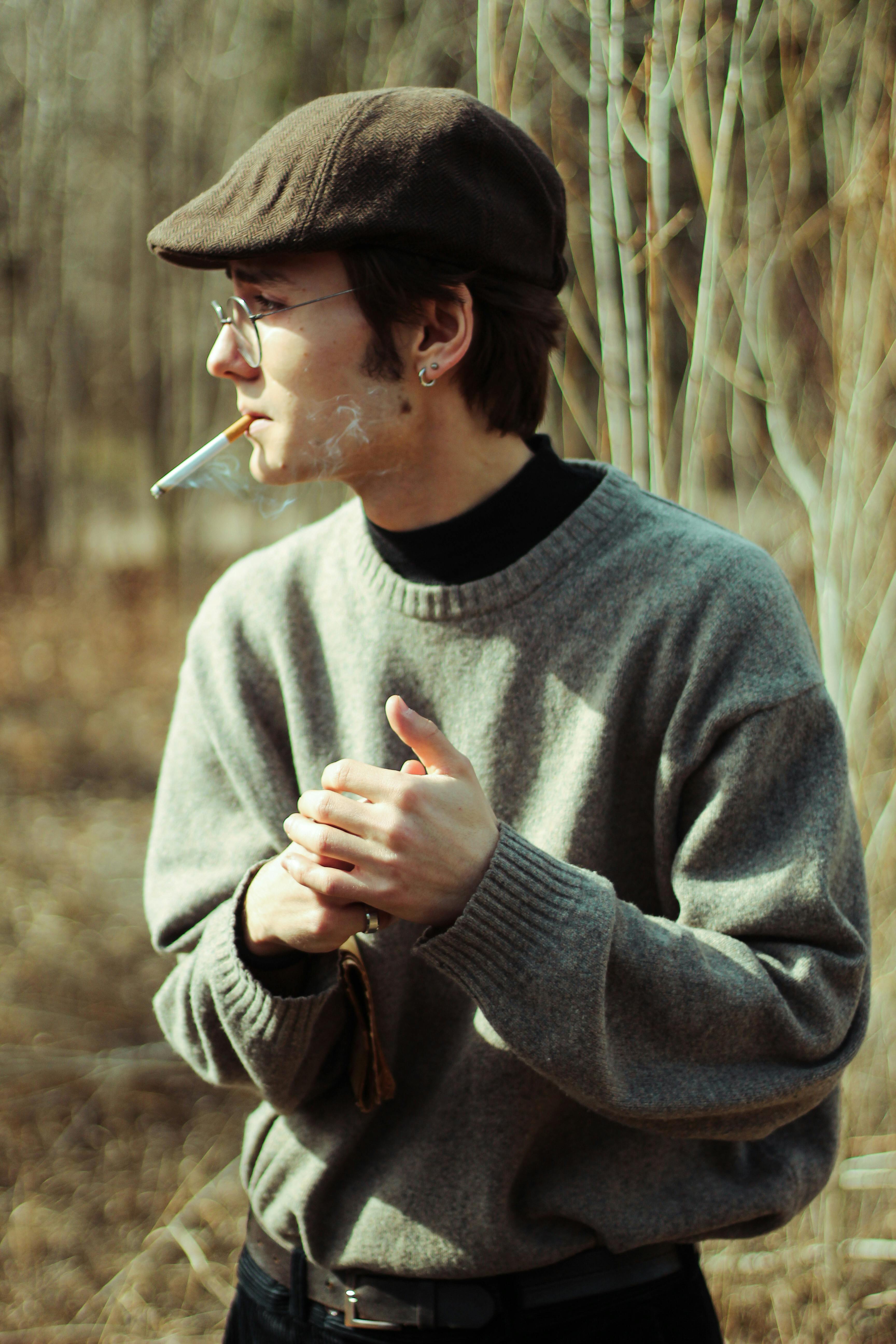 Man in Sweater Smoking Cigarette · Free Stock Photo