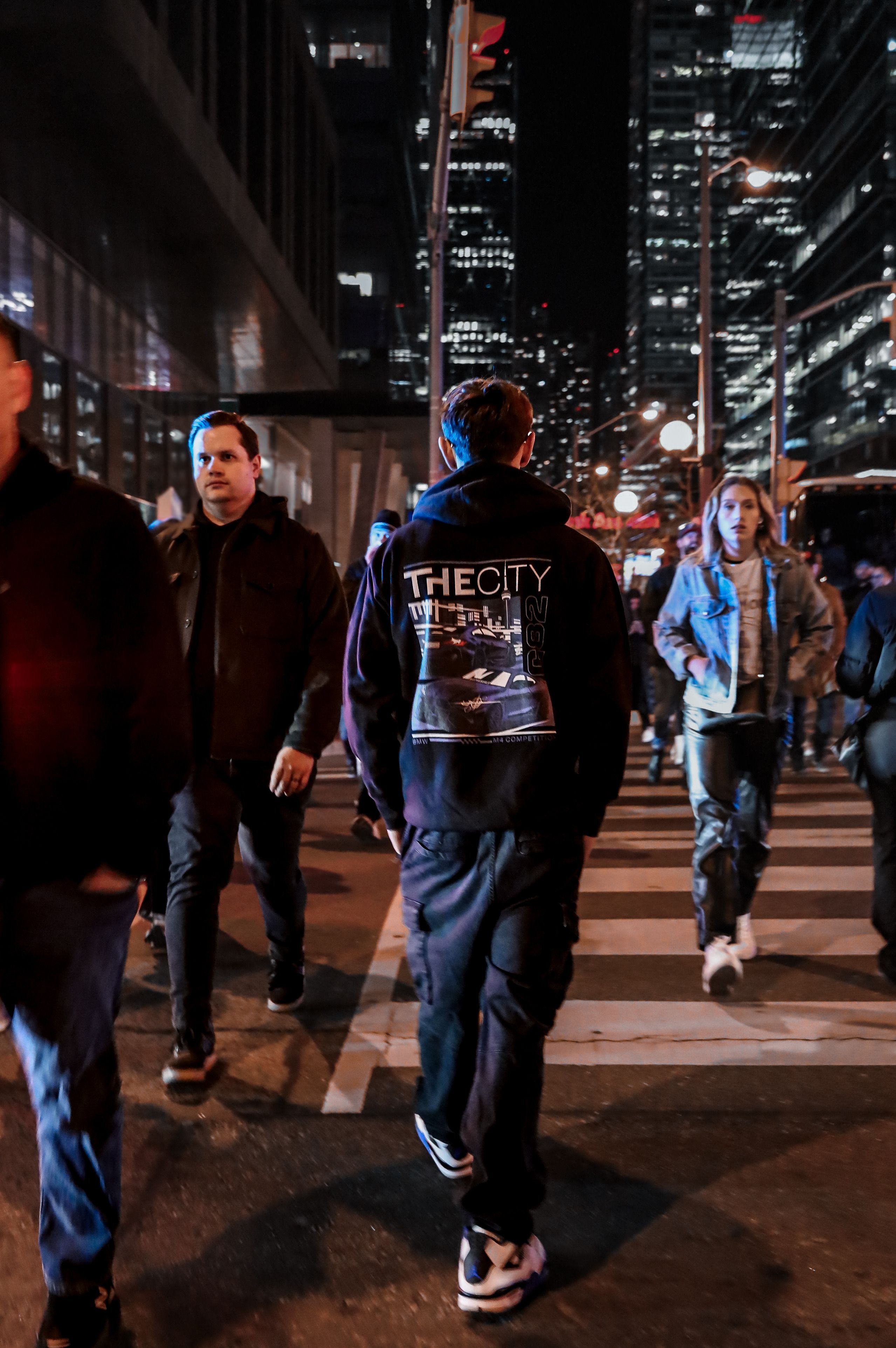 Pedestrians Walking in a City at Night · Free Stock Photo
