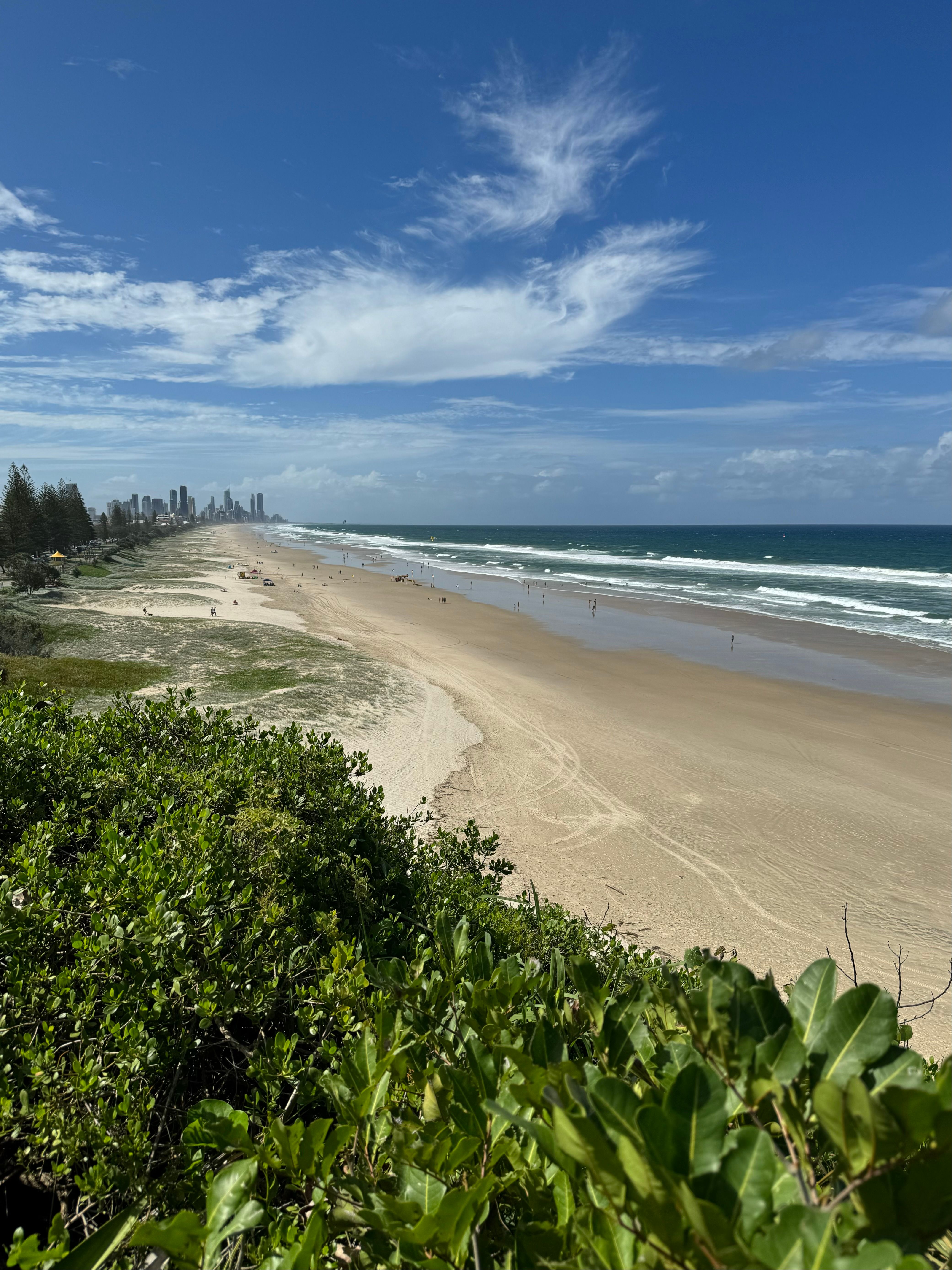 A beach with a sandy shore and green grass · Free Stock Photo
