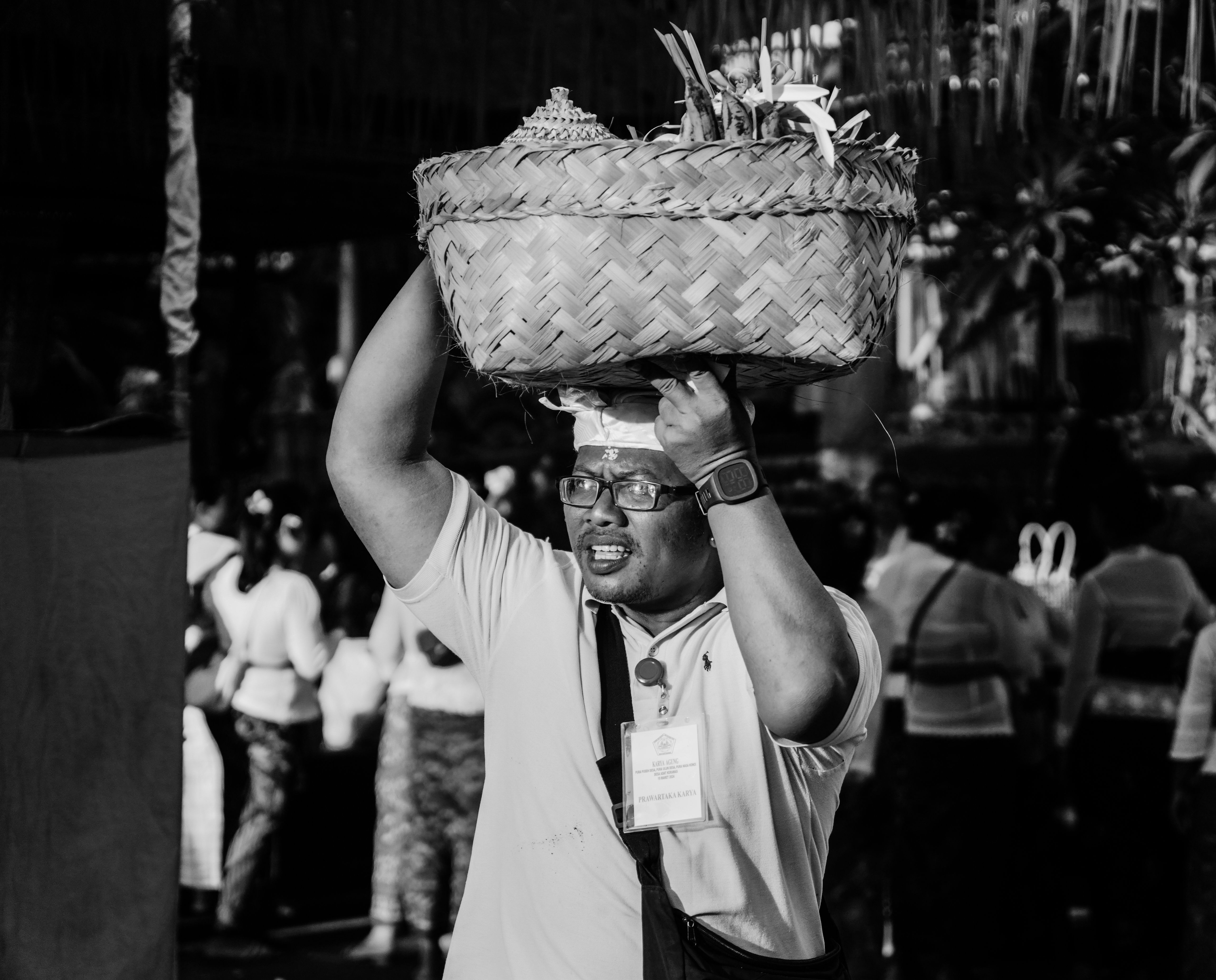Man Wearing an ID Card Carrying a Basket · Free Stock Photo