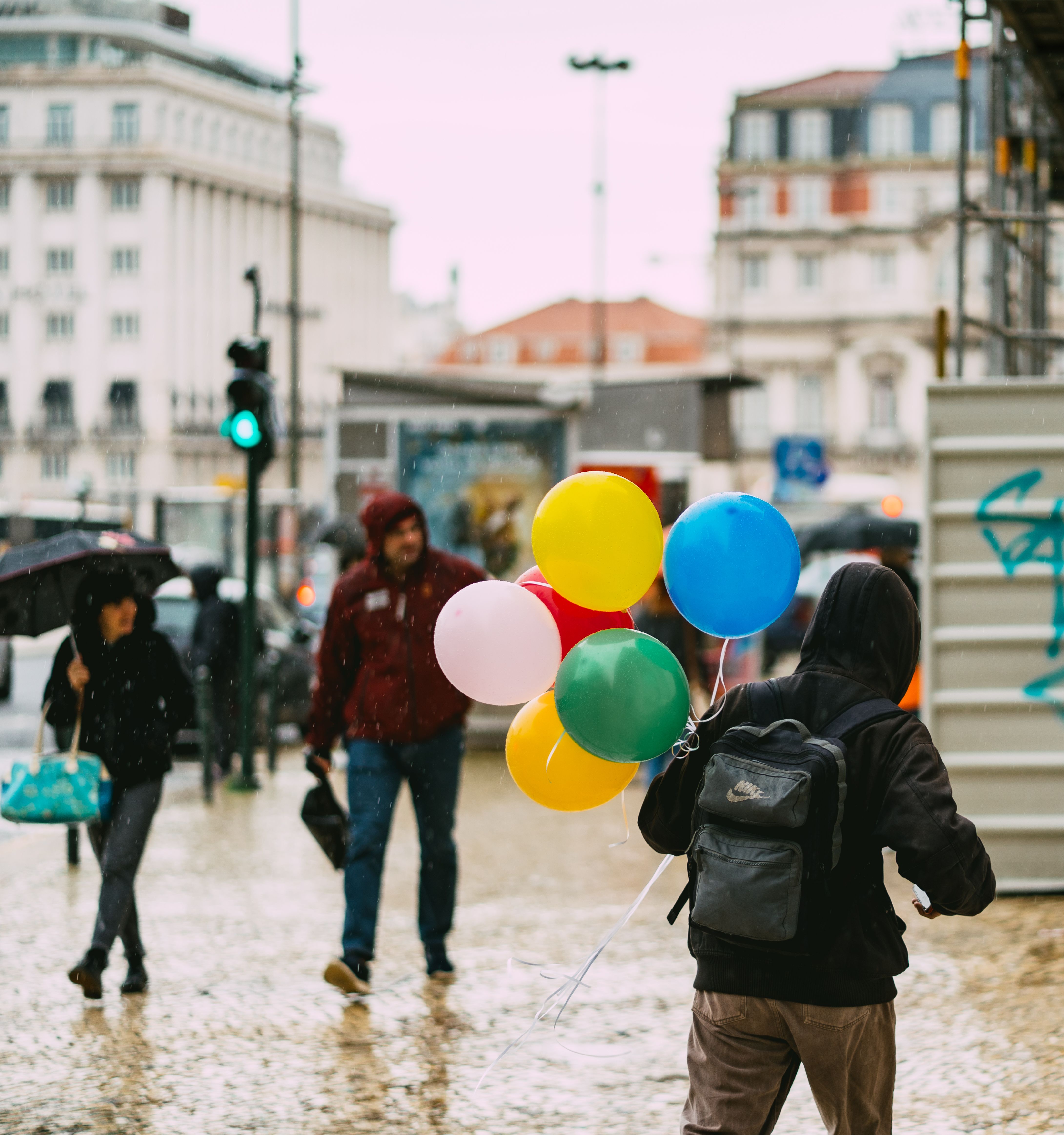 Child Walking with Balloons in Rain · Free Stock Photo
