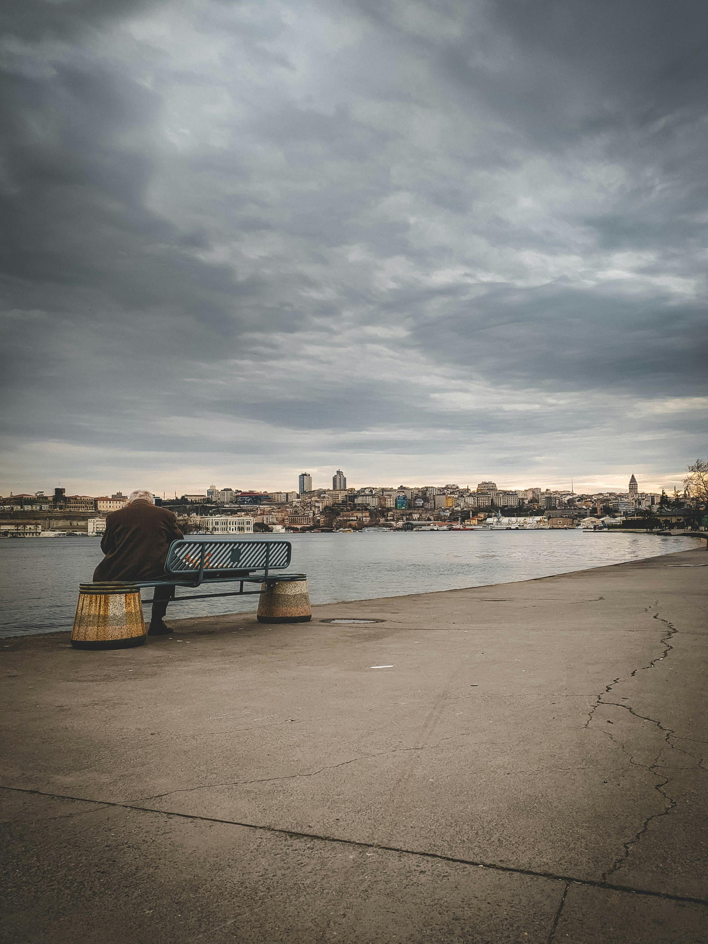 Elderly Man on Bench on Promenade · Free Stock Photo