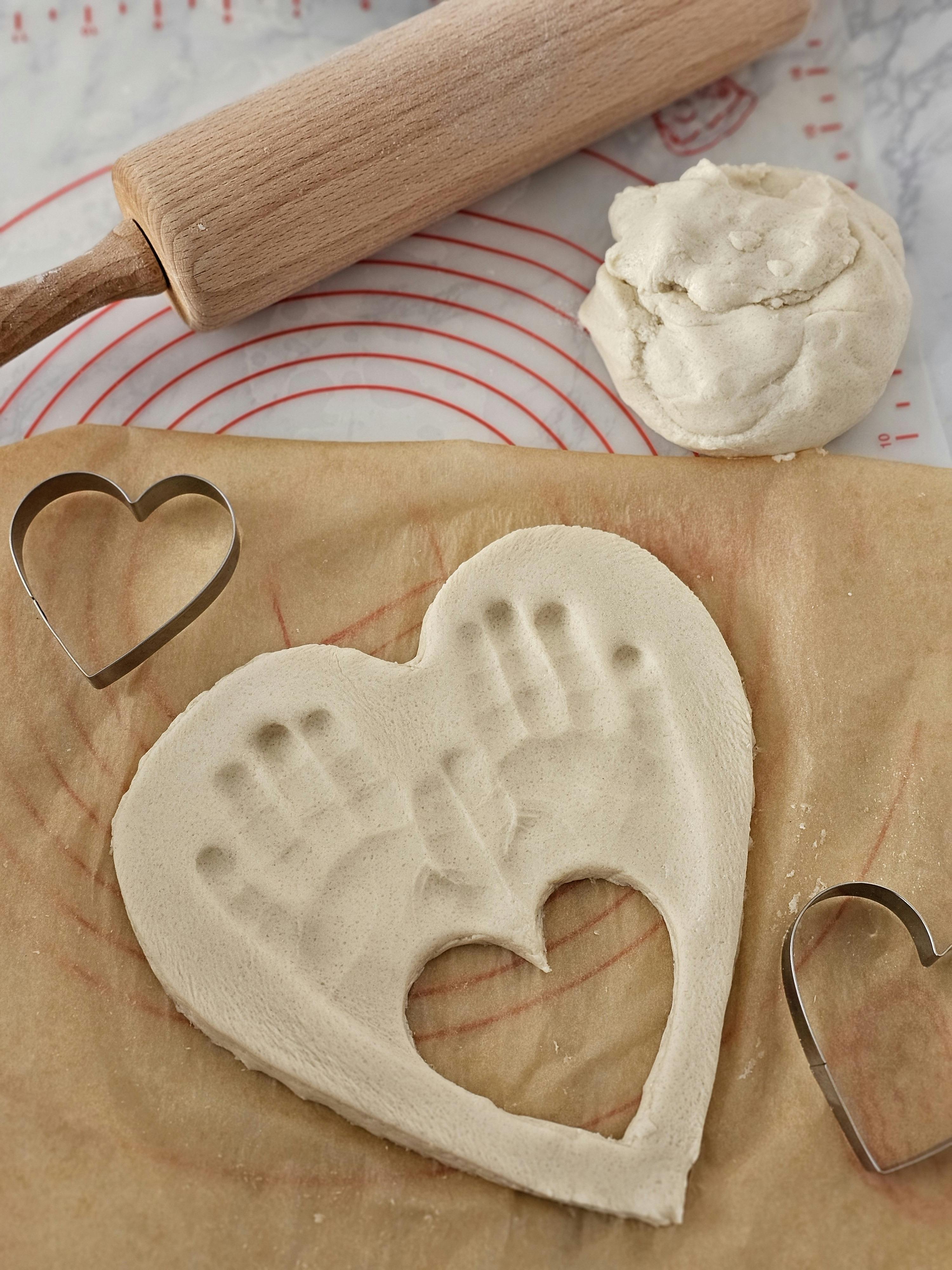 Heart-shaped Dough with Handprints and Cookie Cutters · Free Stock Photo