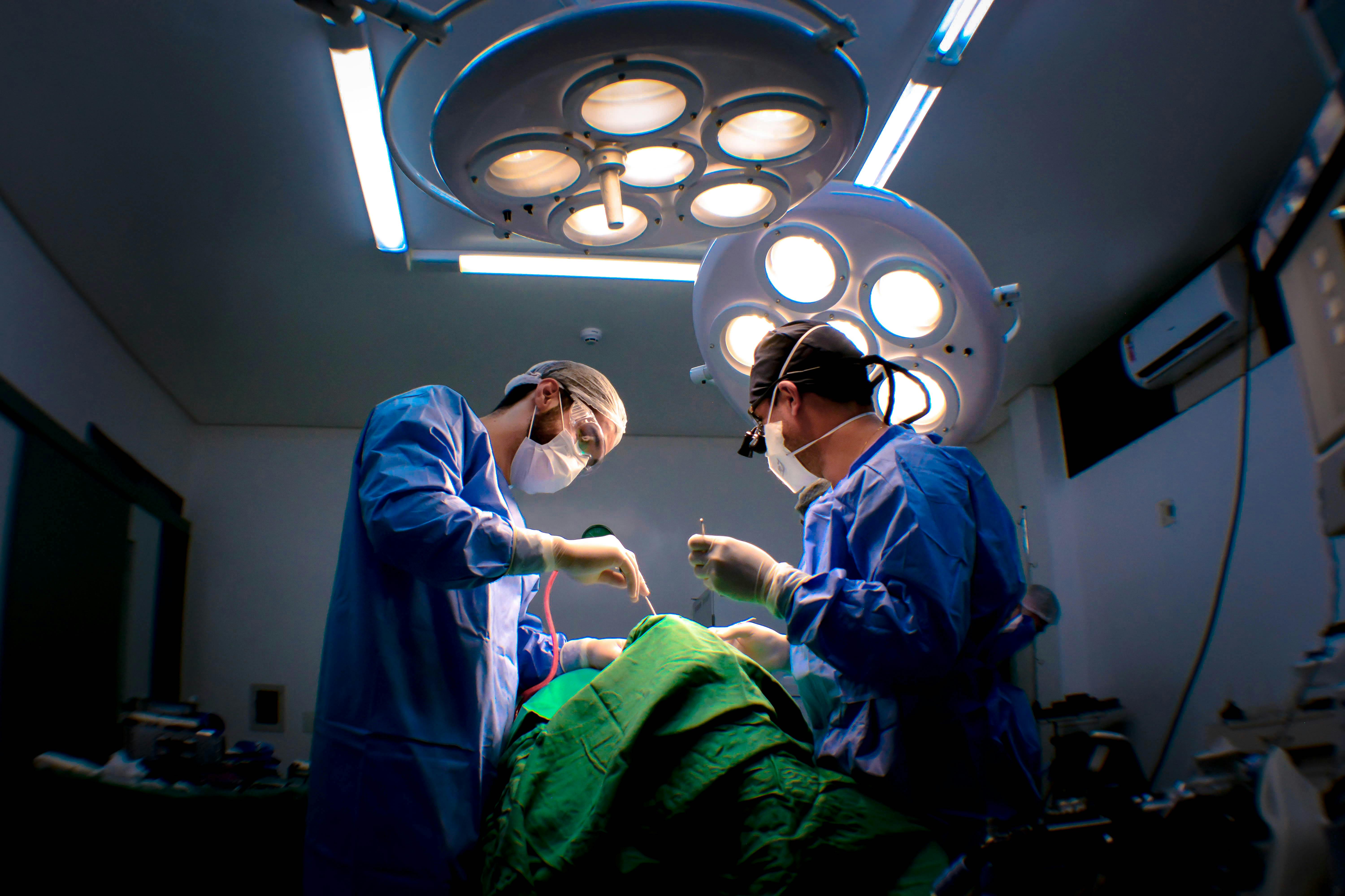 Two Person Doing Surgery Inside Room · Free Stock Photo