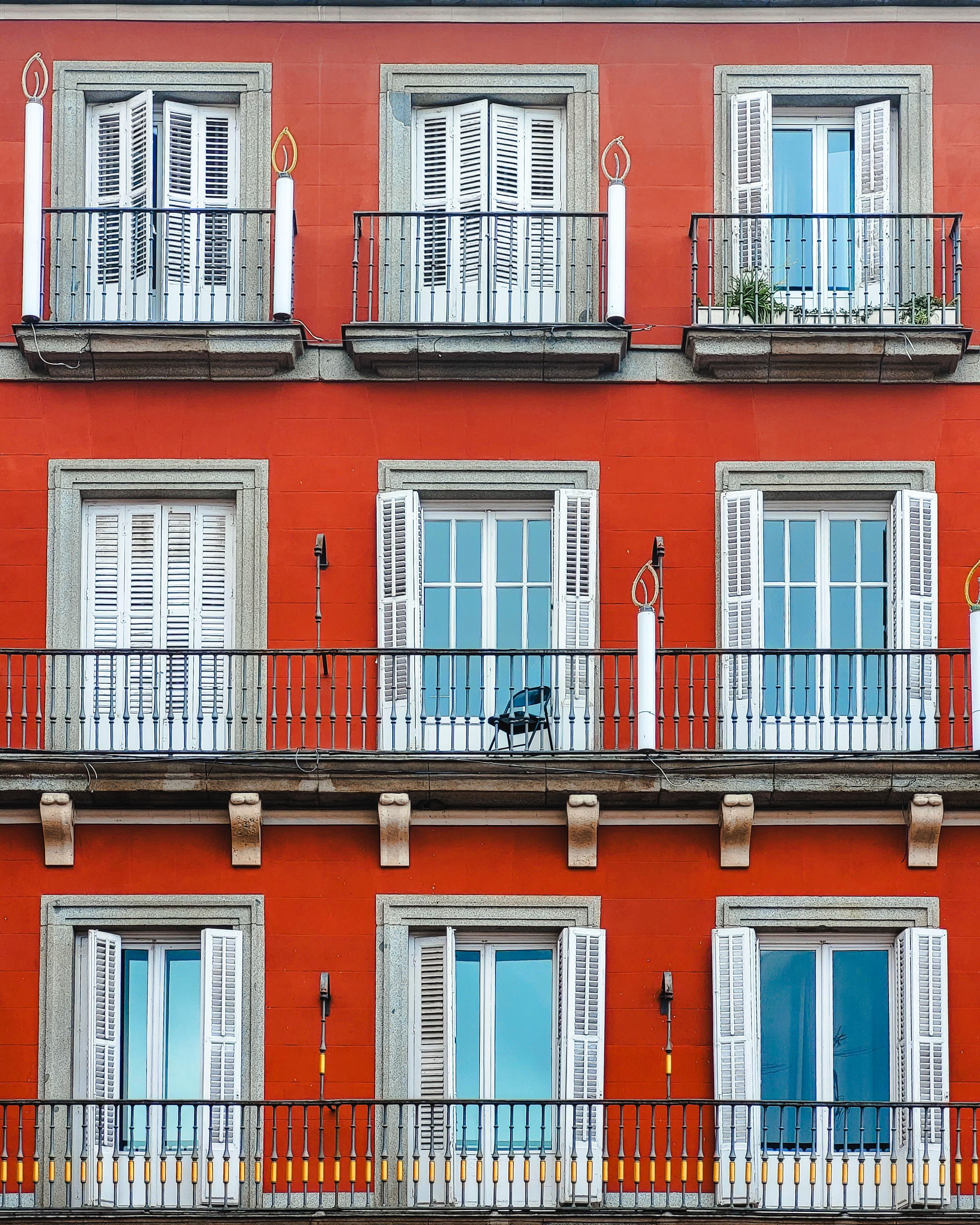 Residential Red Facade with Windows and Balconies · Free Stock Photo