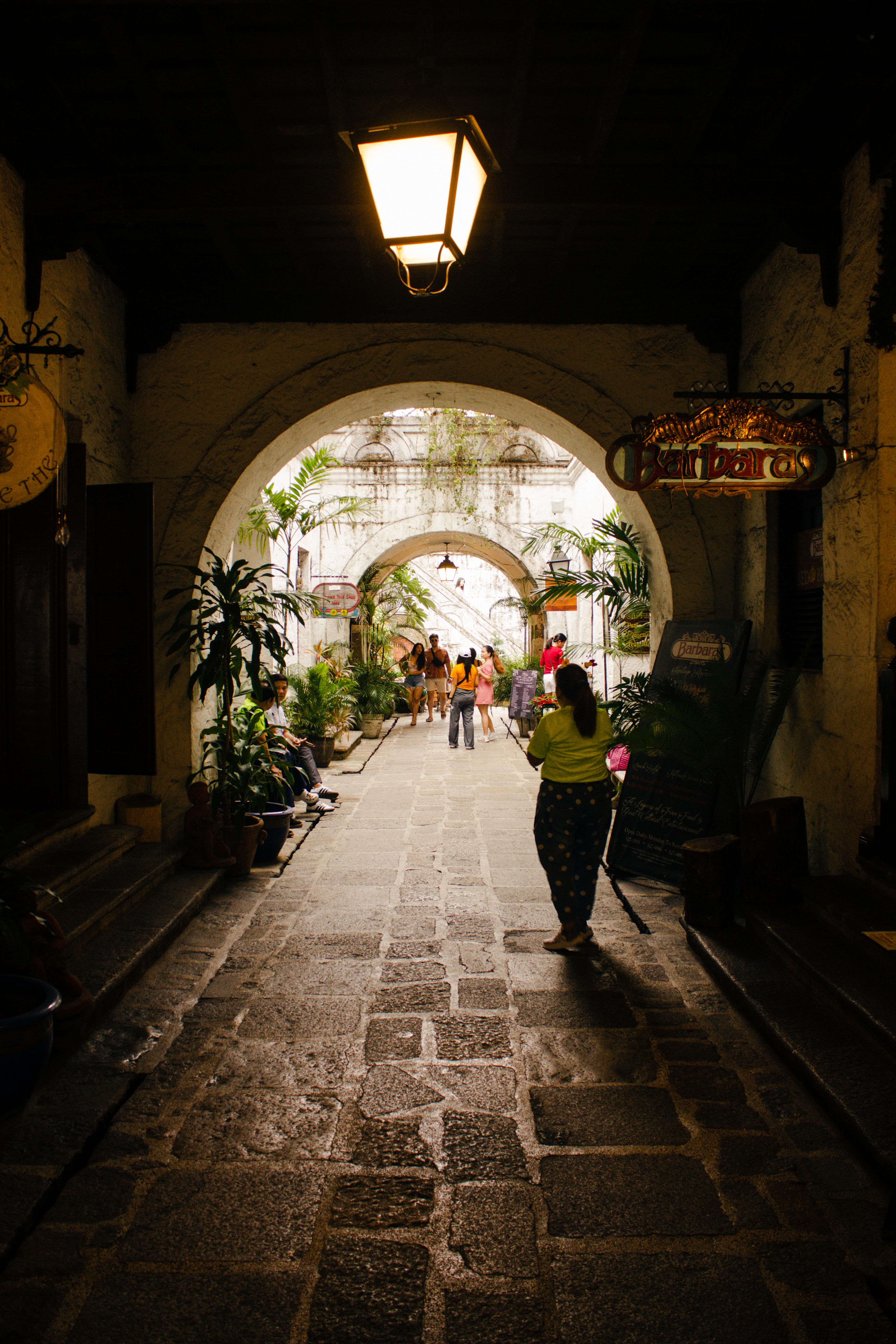 A person walking through an alleyway in a city · Free Stock Photo