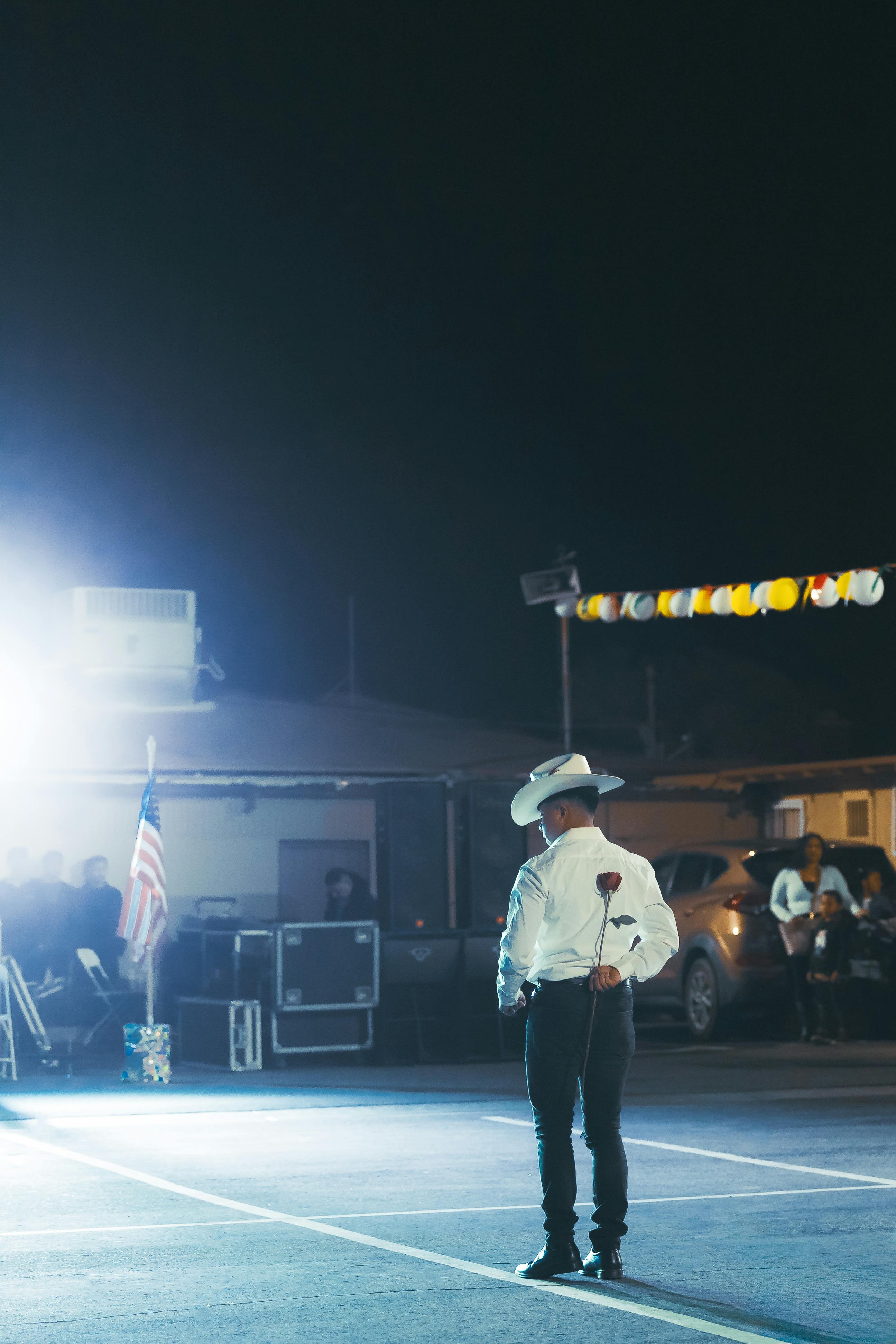 Man in Cowboy Hat Holding Single Red Rose · Free Stock Photo