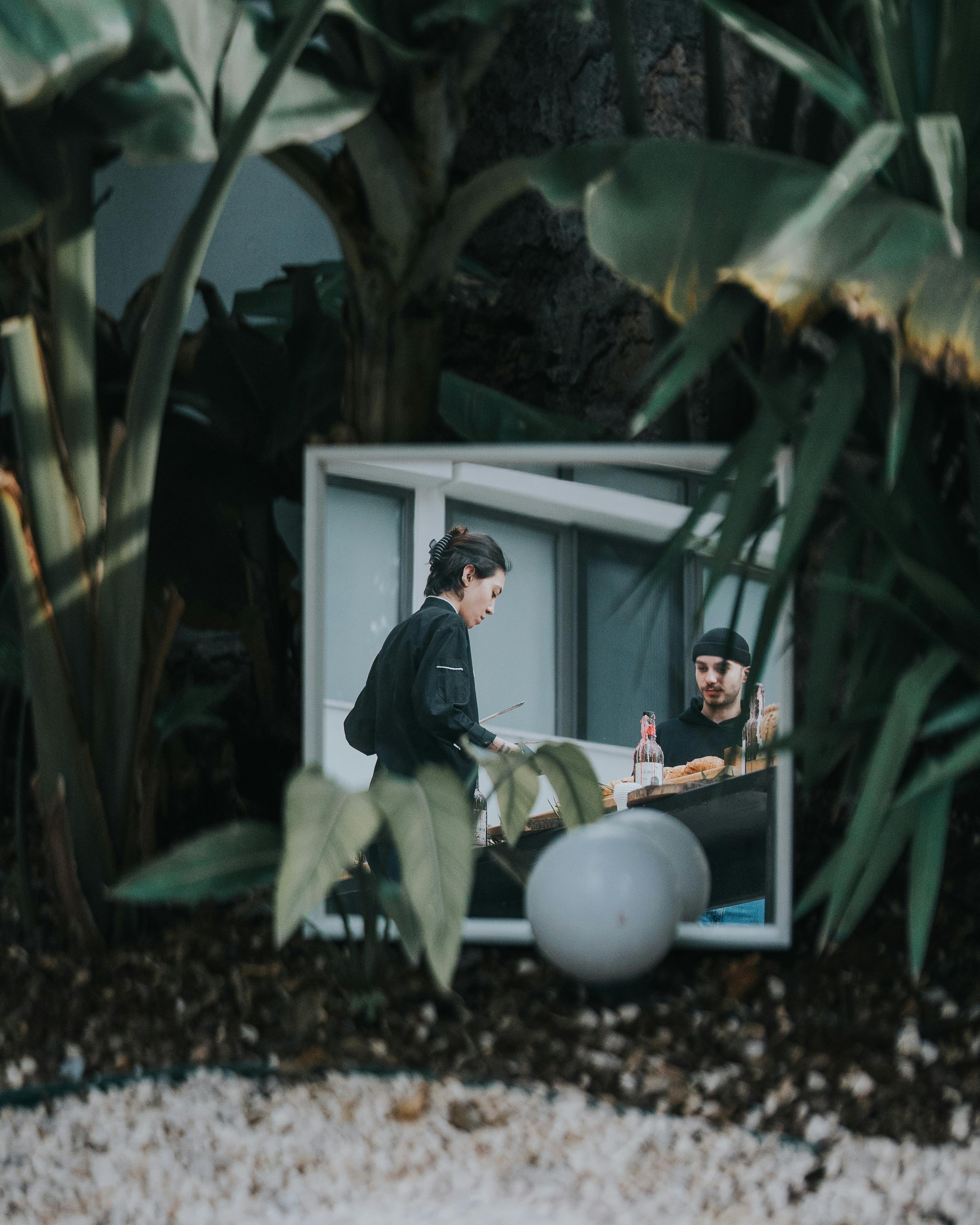 Two People Reflecting in a Mirror · Free Stock Photo