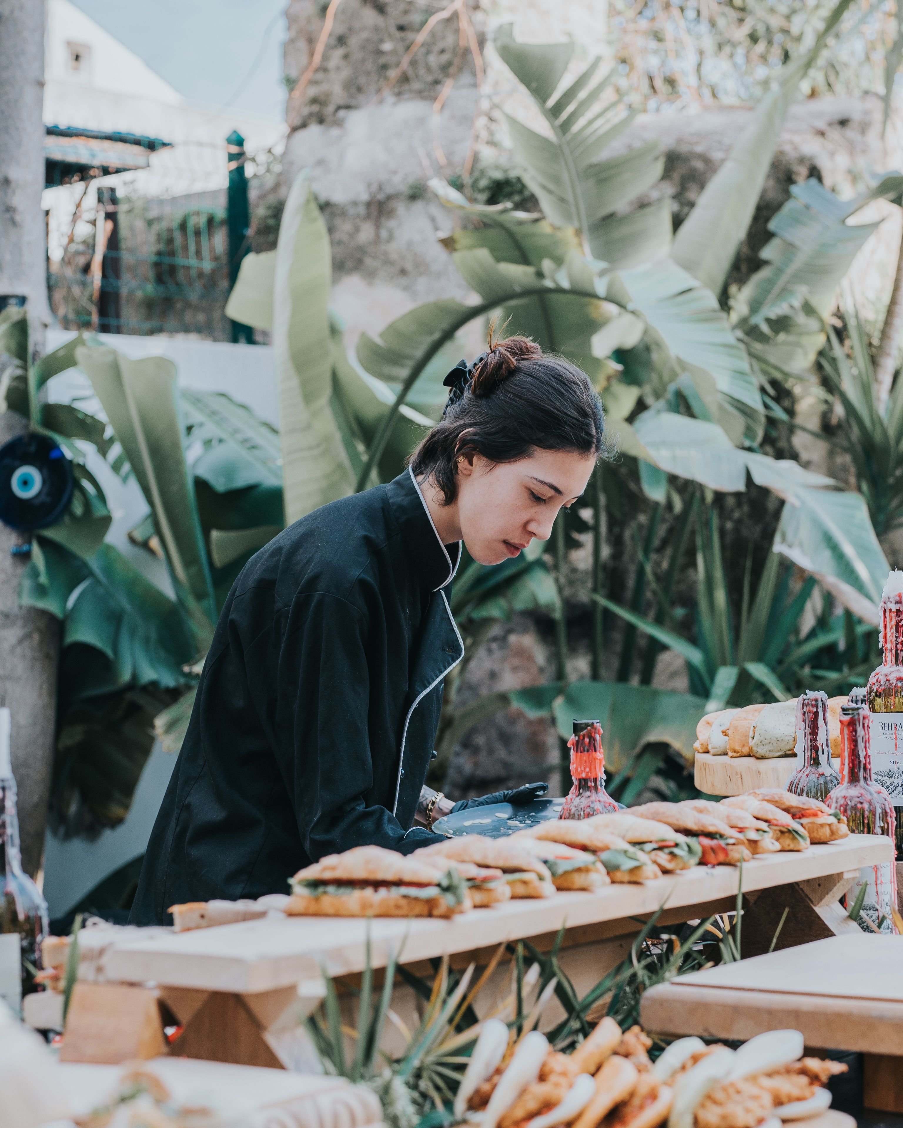 Woman in Black Jacket Selling Sandwiches · Free Stock Photo